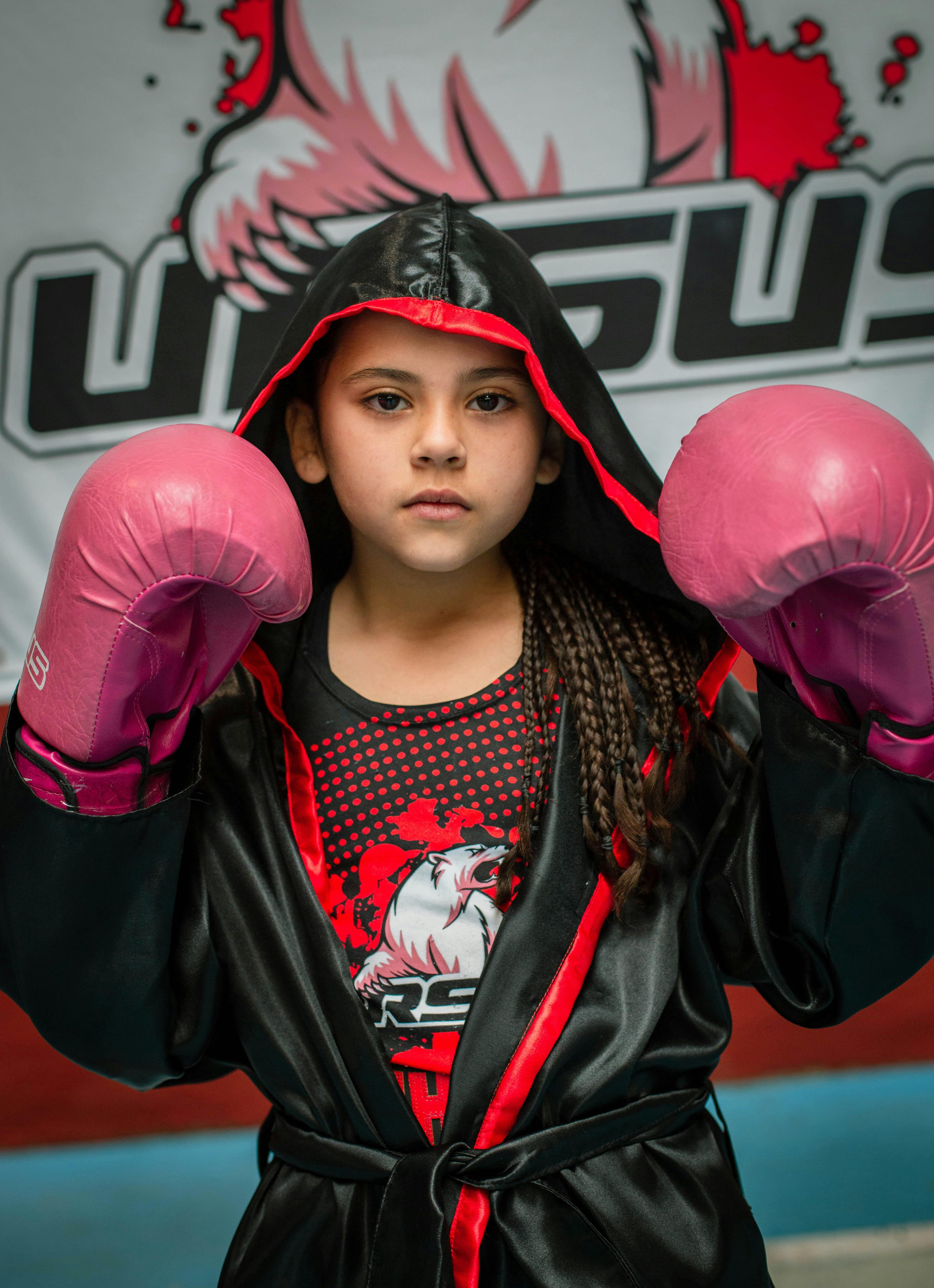 A Boy Wearing Boxer Gloves and a Robe · Free Stock Photo