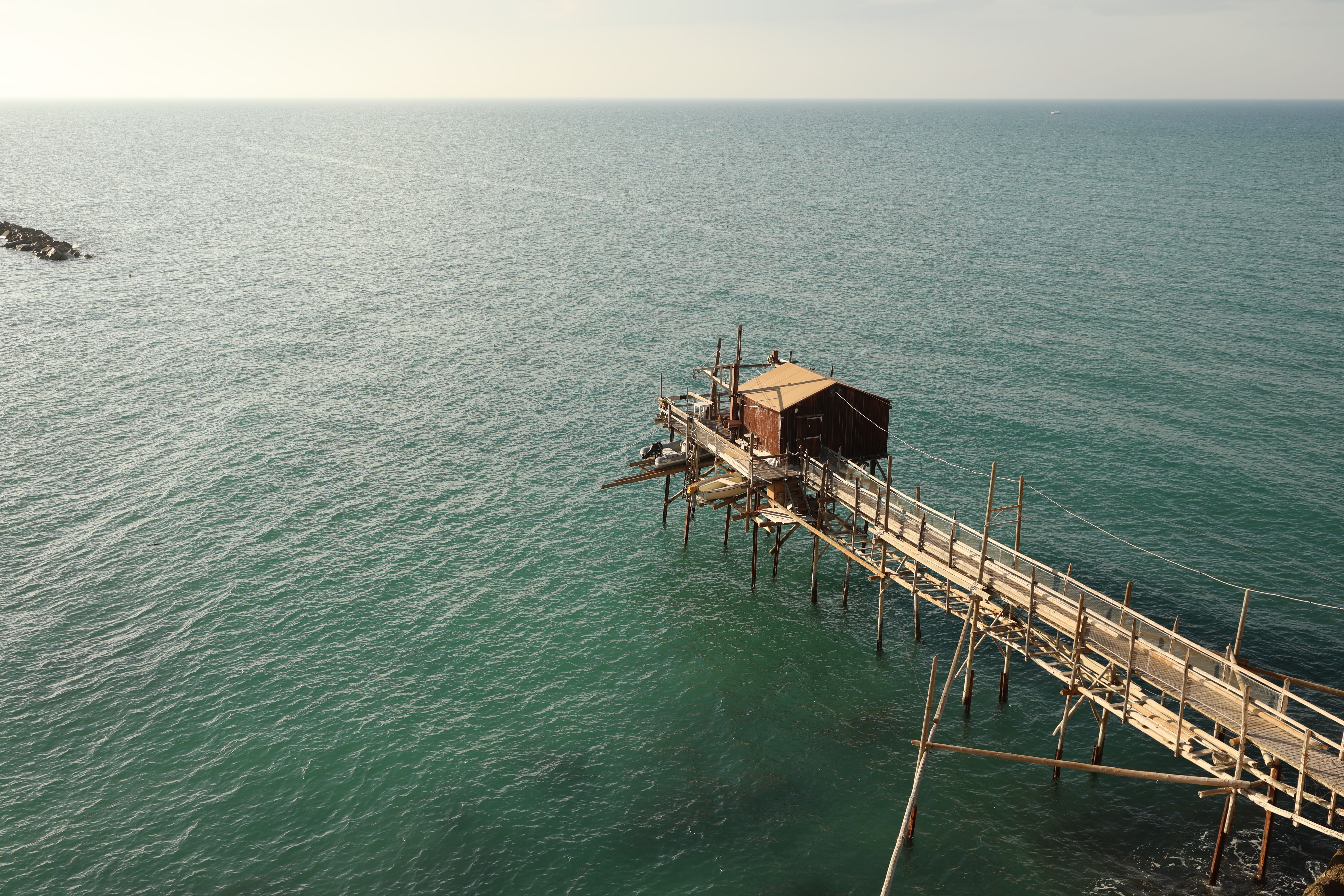 An Aerial Shot of a Wooden Pier with a House · Free Stock Photo