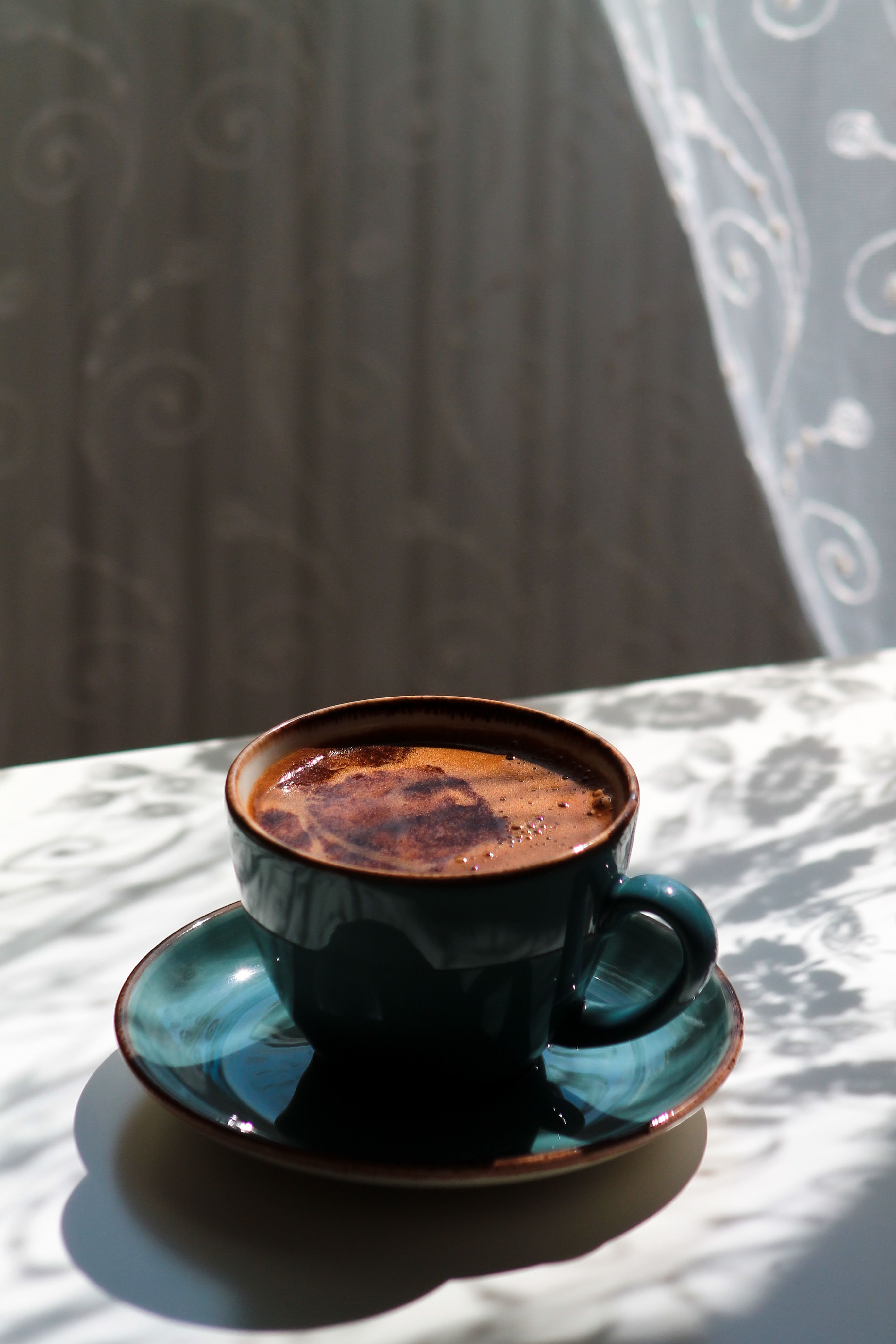 Elegant Espresso Cup in Sunlight · Free Stock Photo
