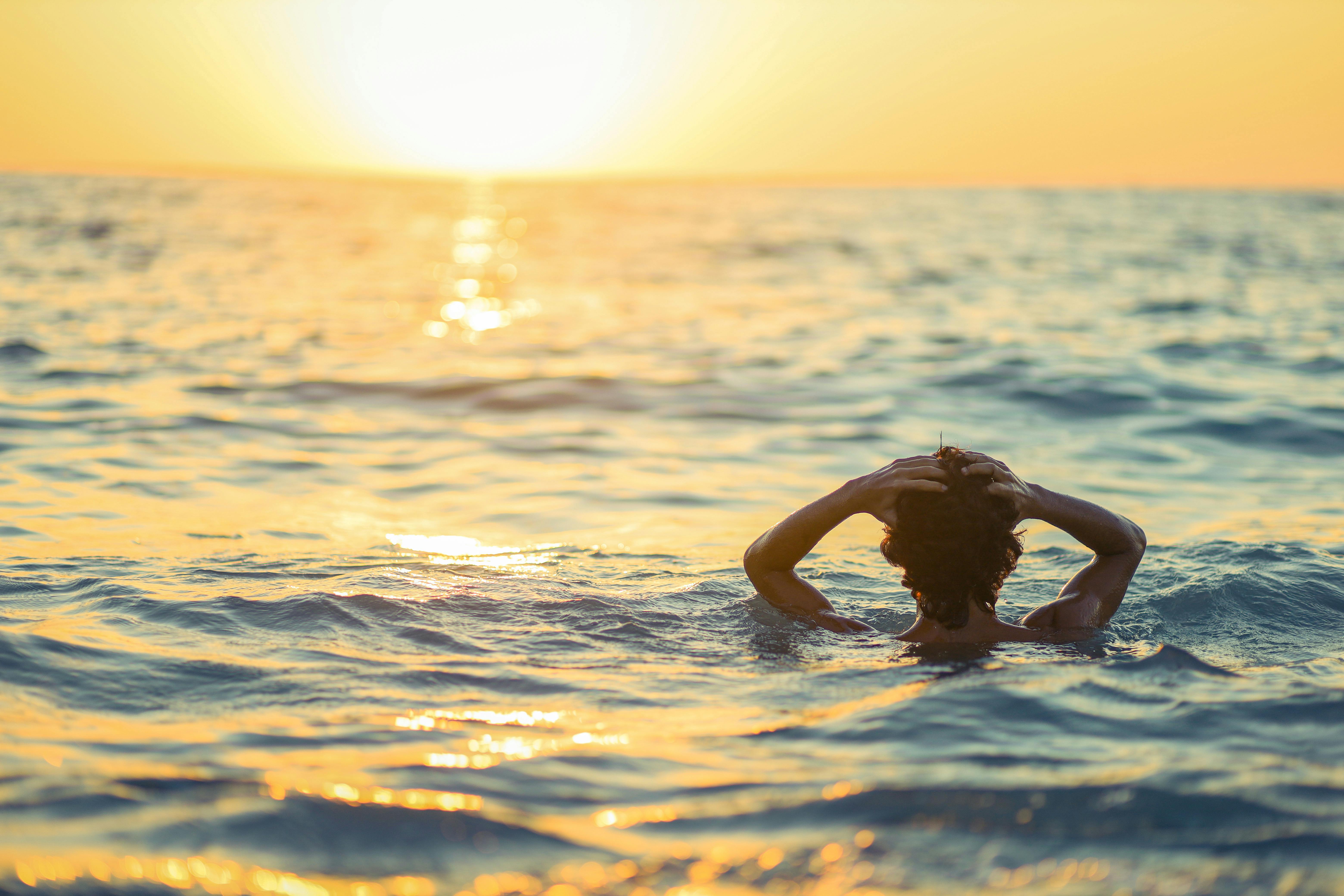Person Having Fun Swimming on Sea · Free Stock Photo