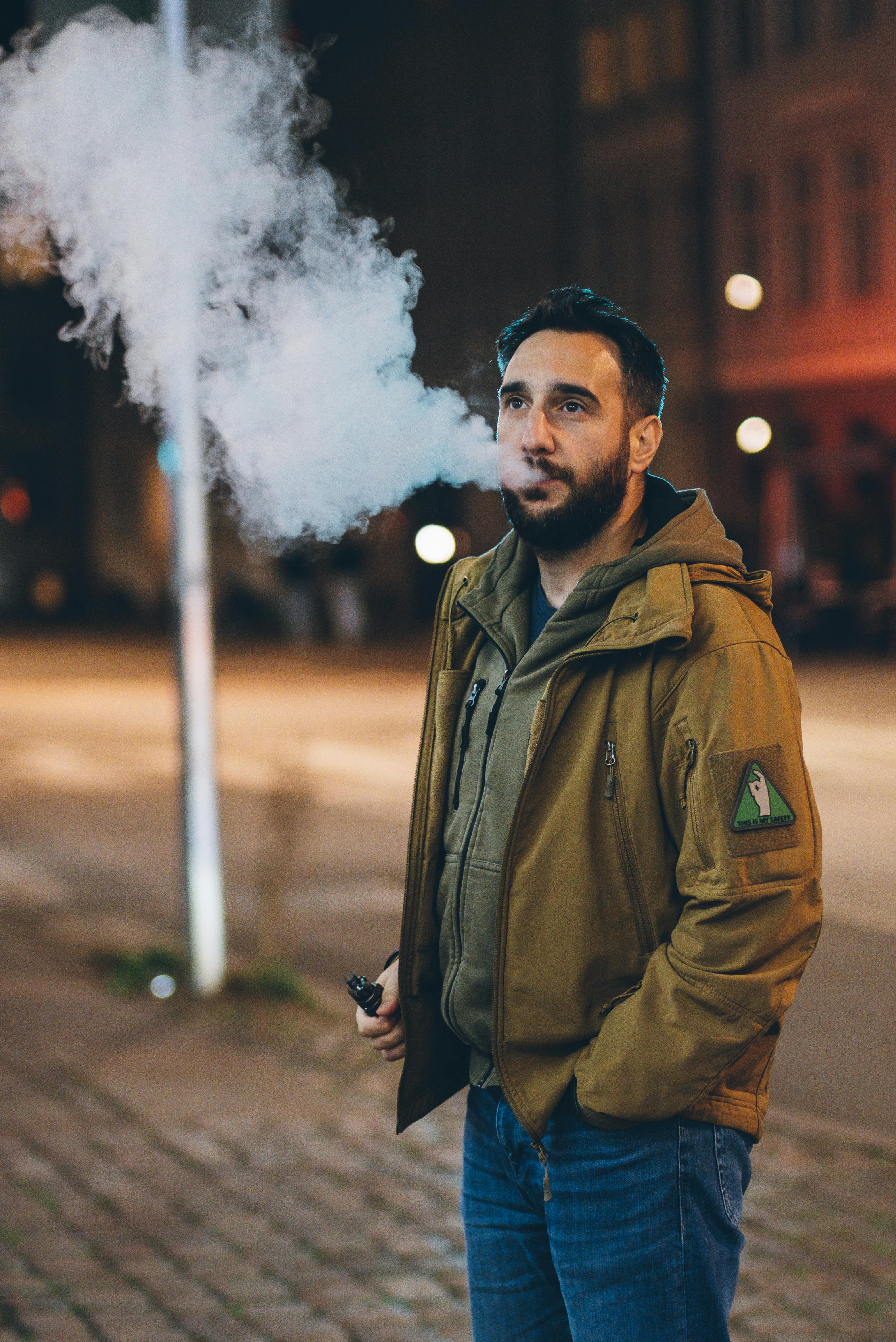 Man Holding Logic Vape Pens in Hands · Free Stock Photo