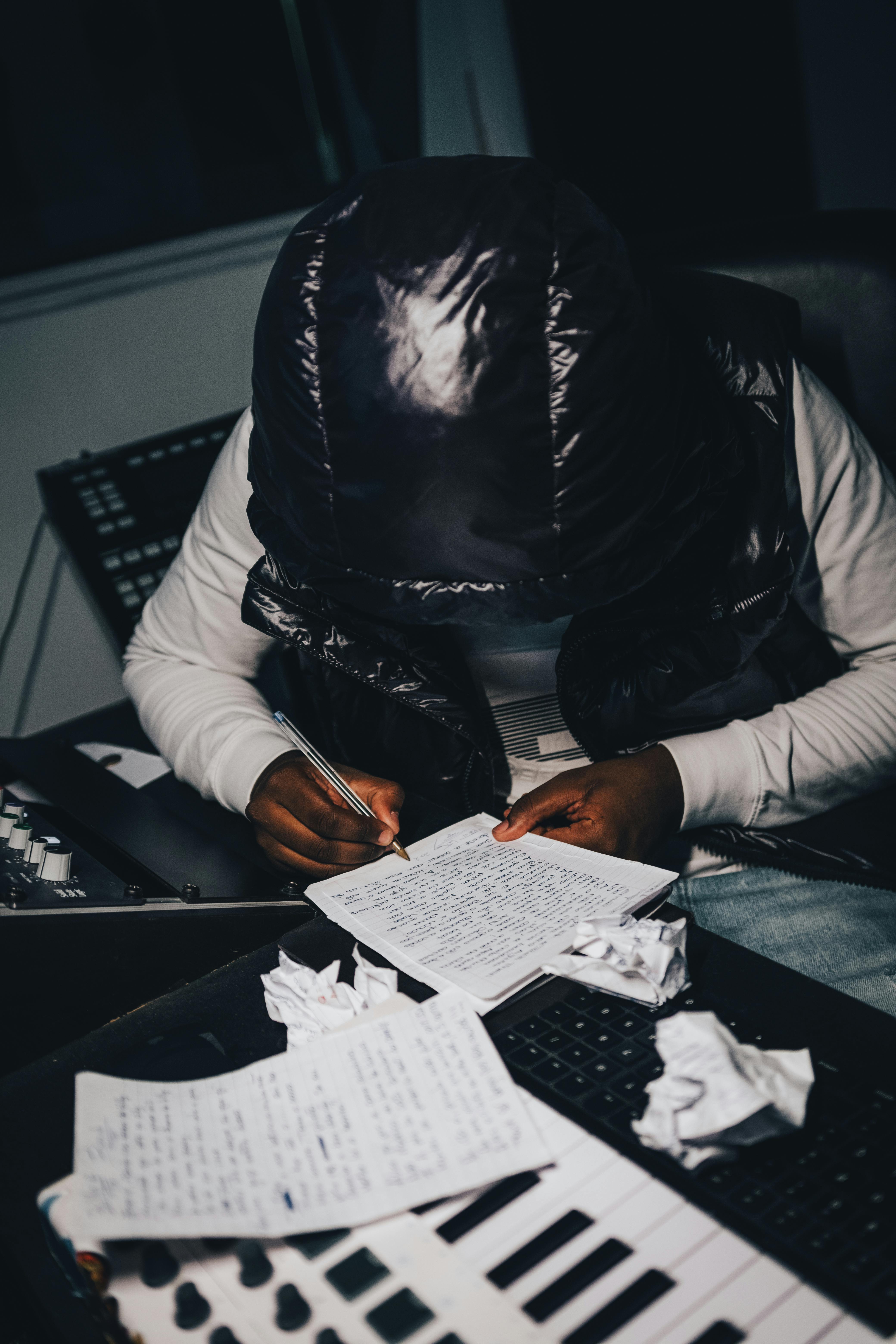 Person in Robes with Hood Standing with Puppets · Free Stock Photo