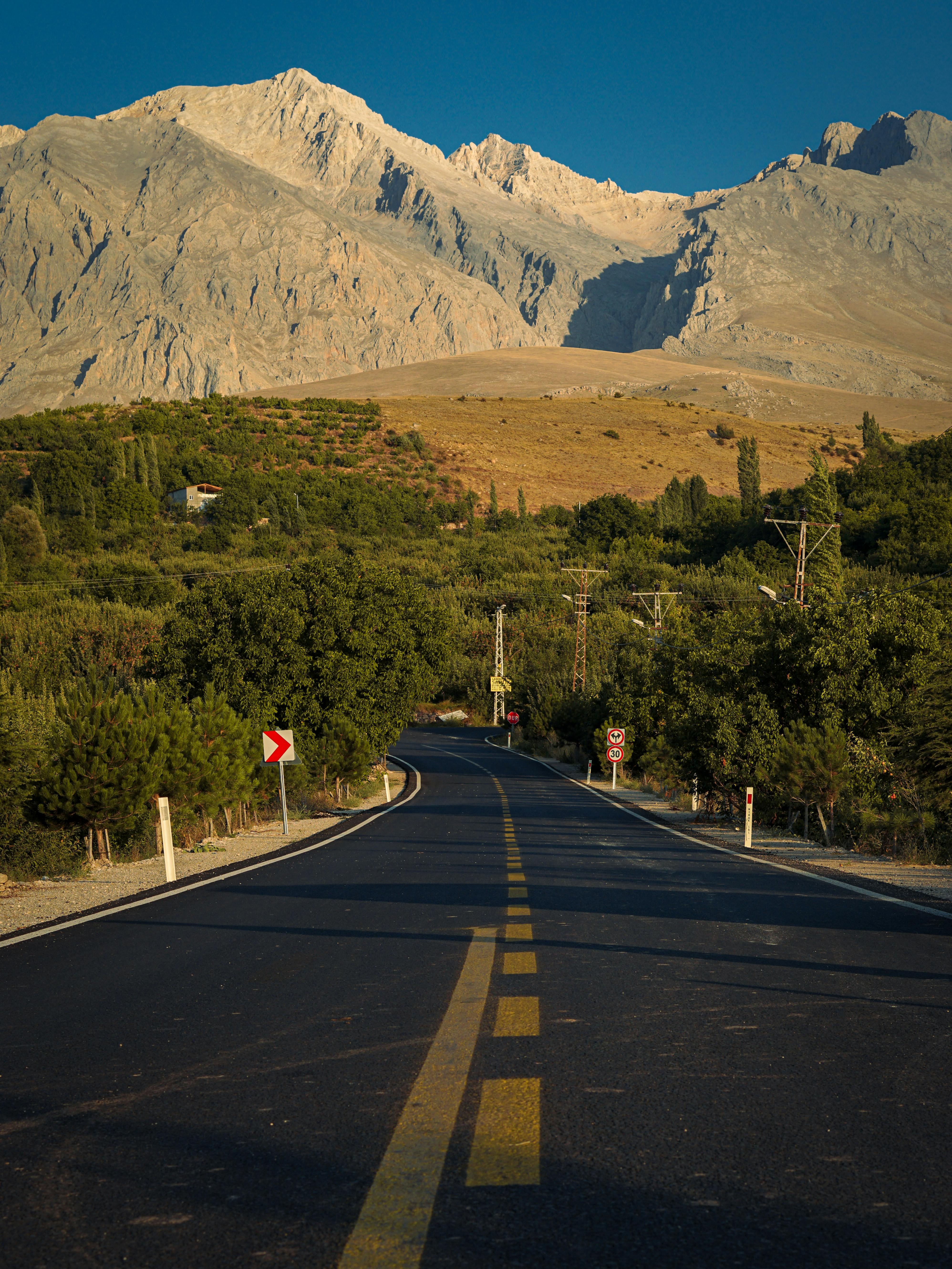 Asphalt Road Going to a Mountain · Free Stock Photo