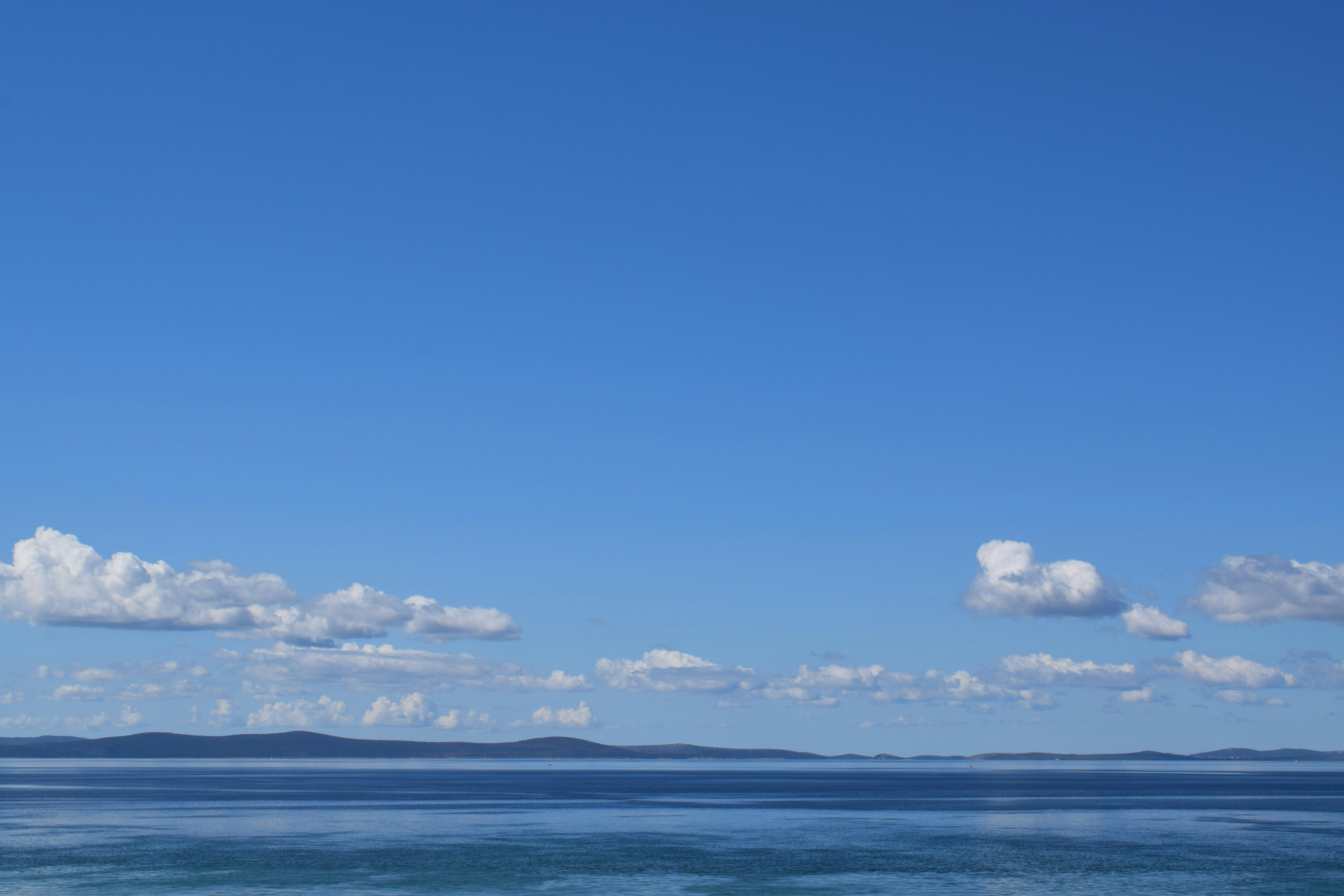 Calming Sea Under Blue Sky · Free Stock Photo