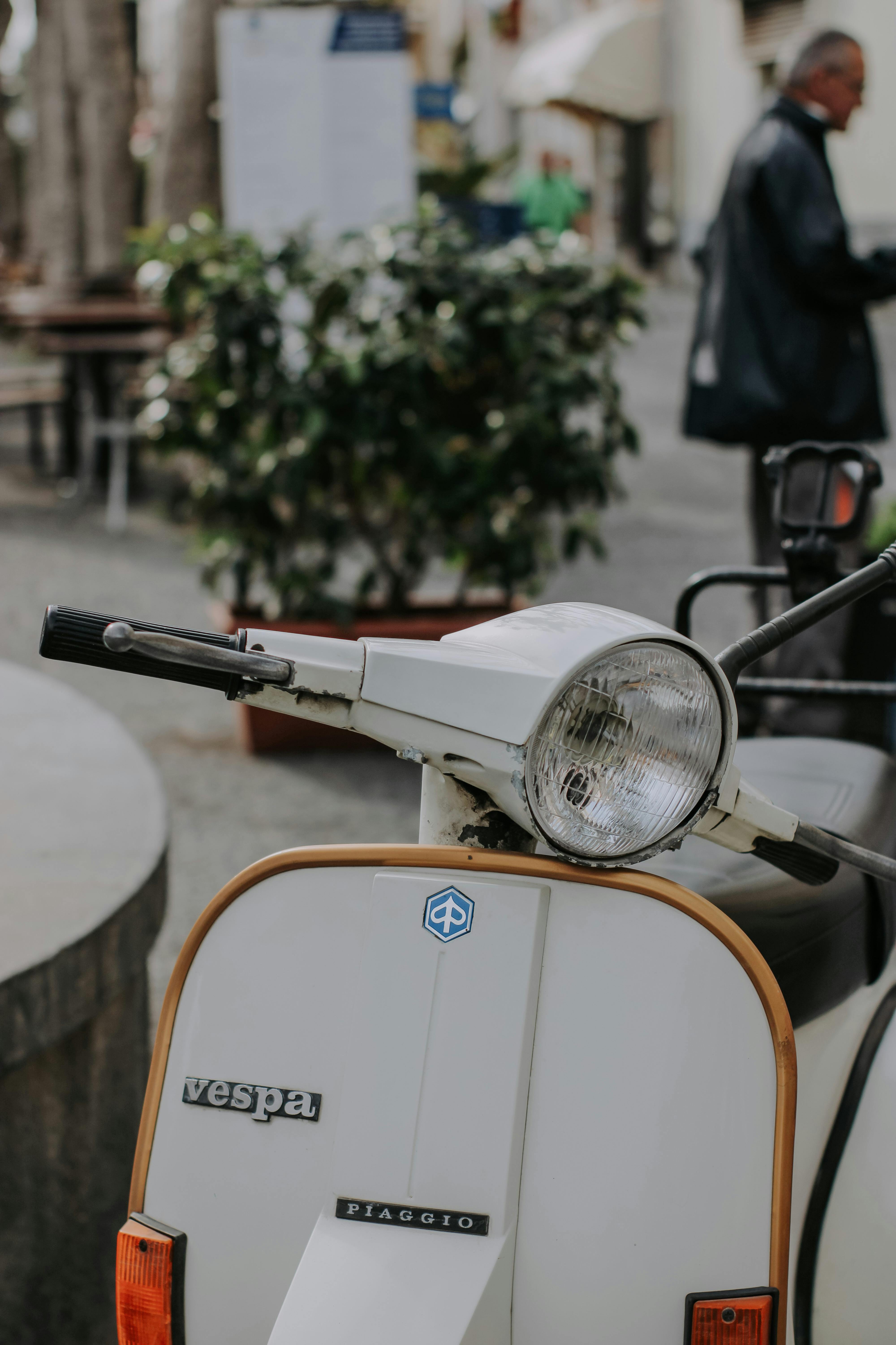 A White Scooter Parked on the Street · Free Stock Photo