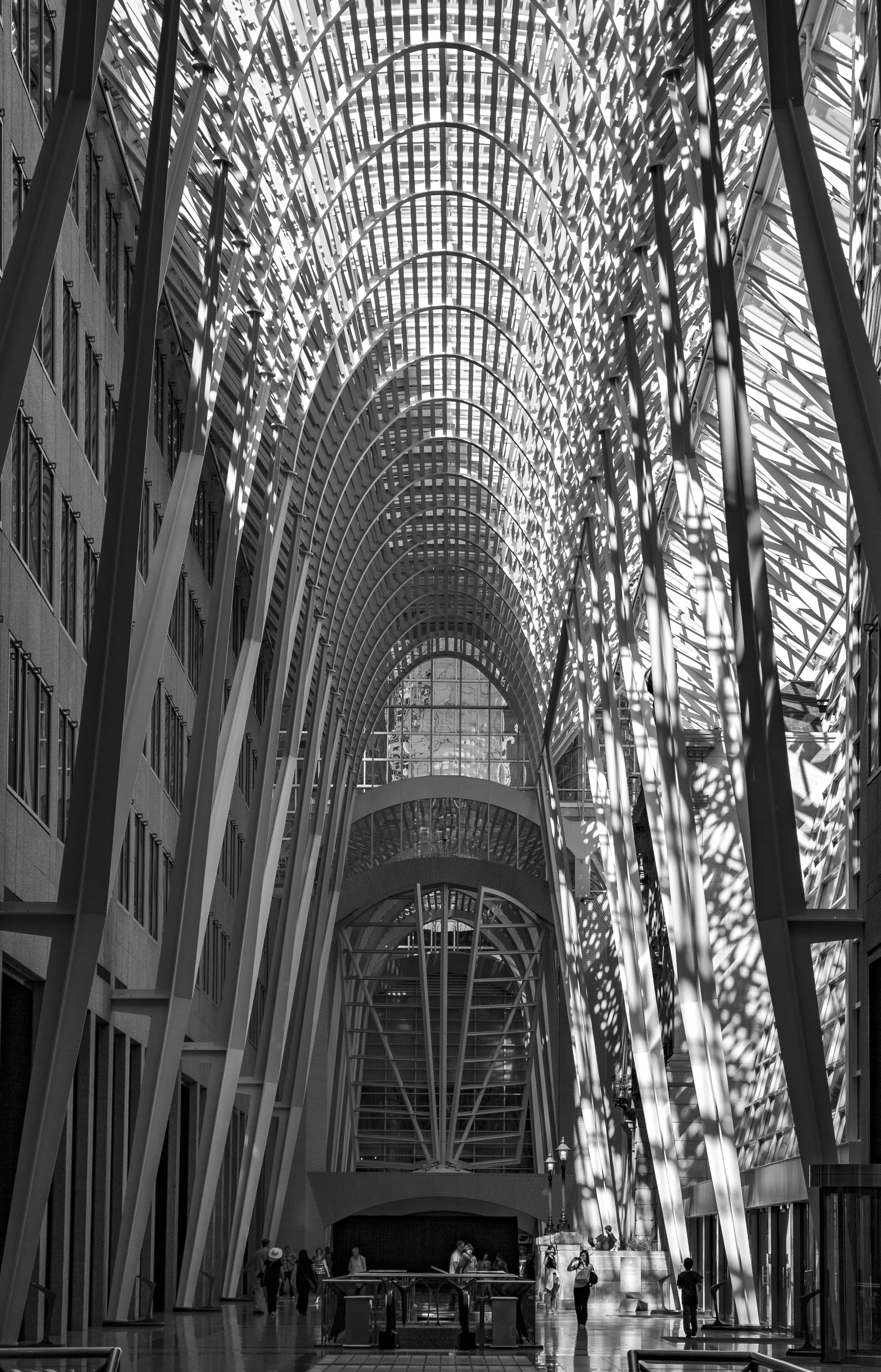 Person under parabolic dome of modern atrium · Free Stock Photo