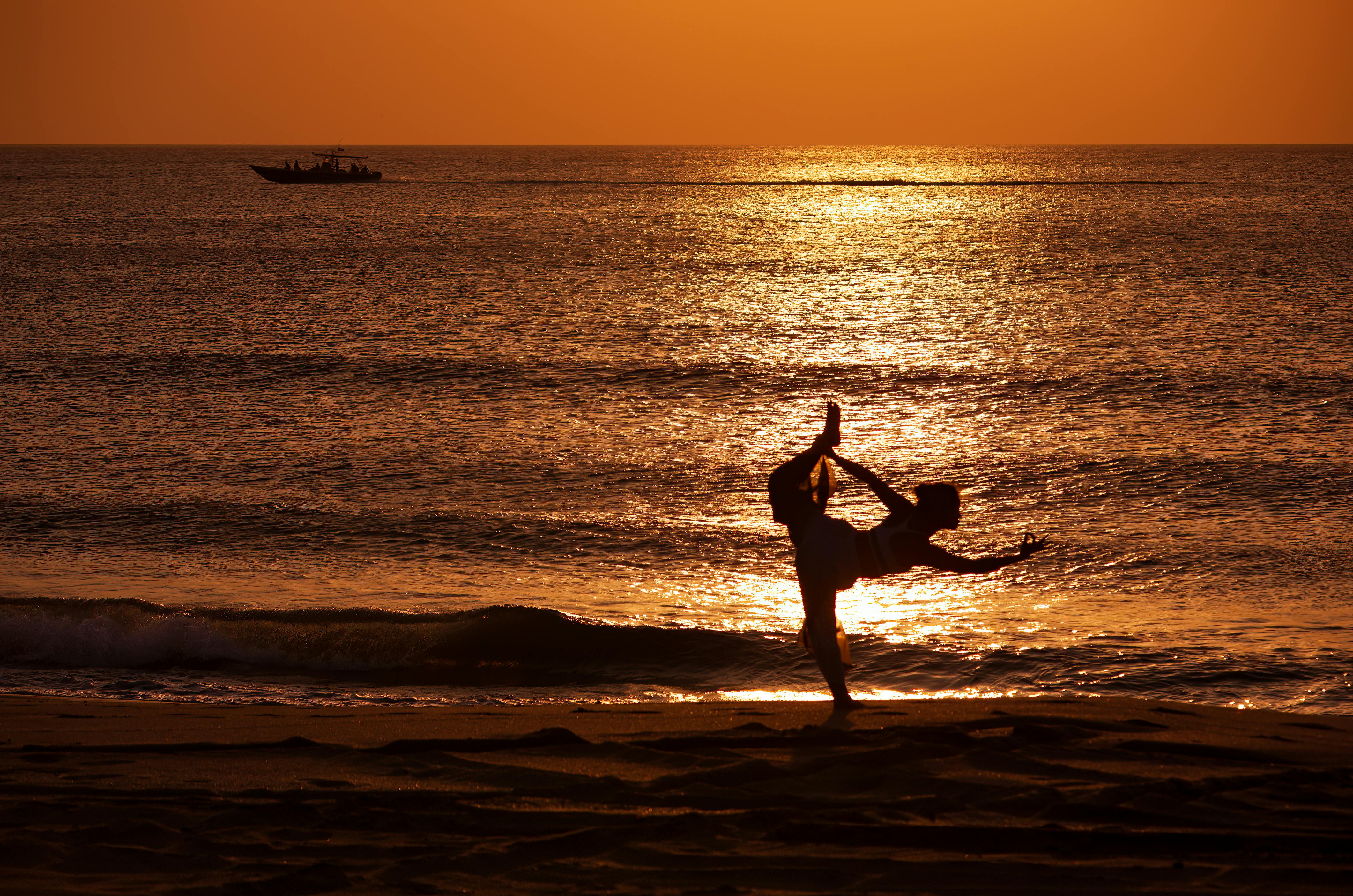 Silhouette of a Woman Doing a Standing Split by the Shore · Free Stock ...