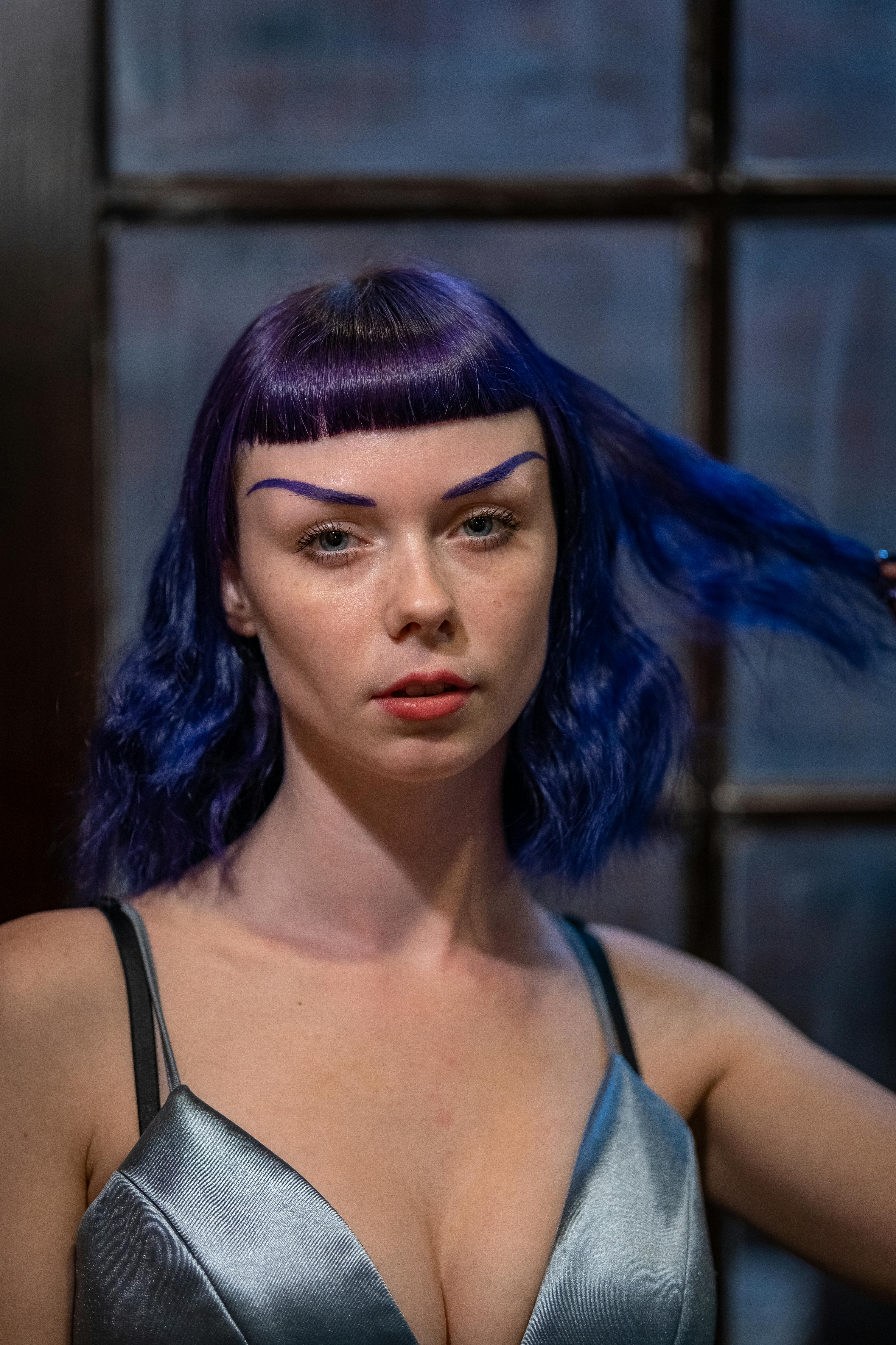 A Woman Touching Her Blue Hair · Free Stock Photo