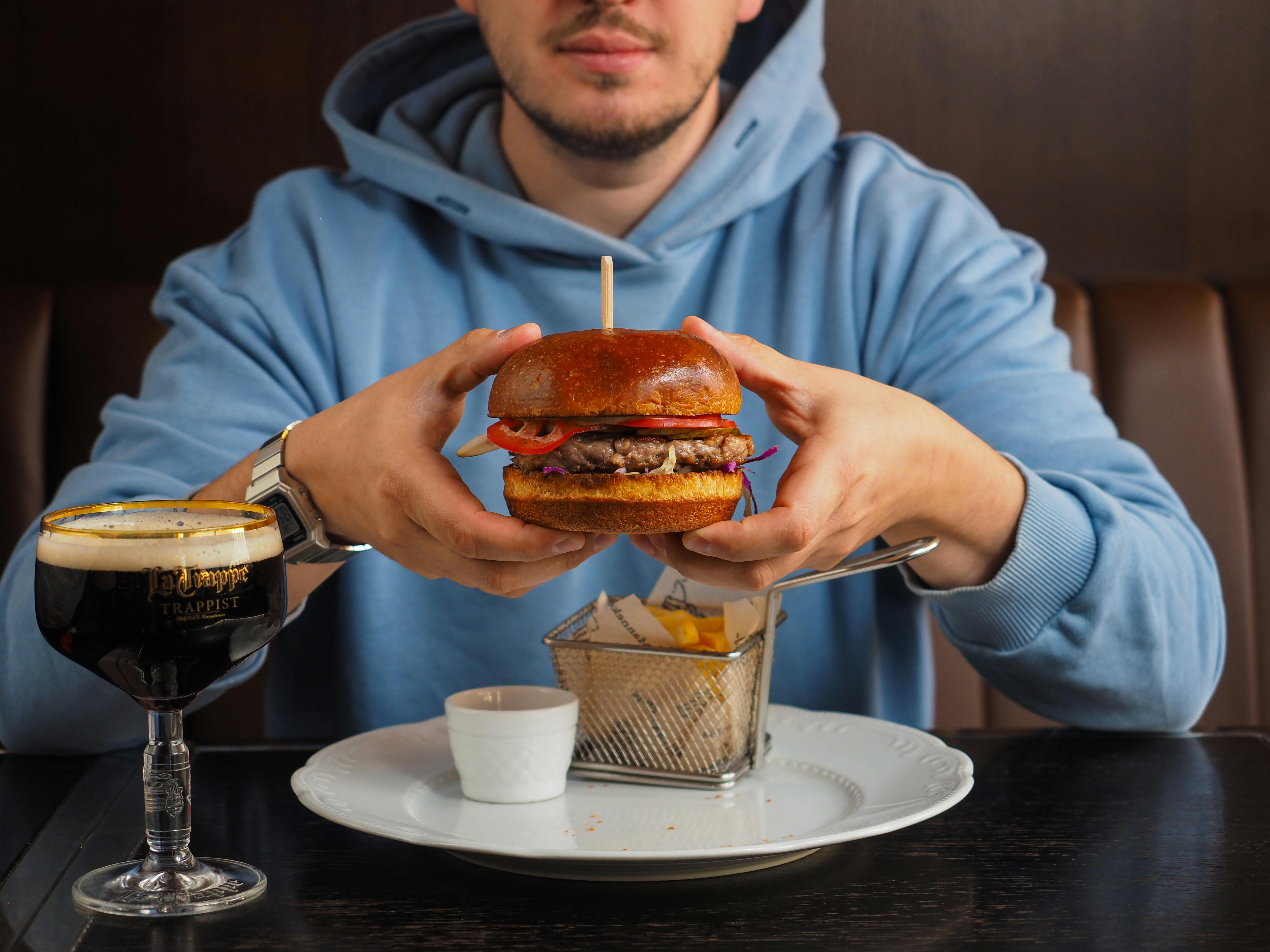 Photo of a Cheeseburger Near a Magazine · Free Stock Photo