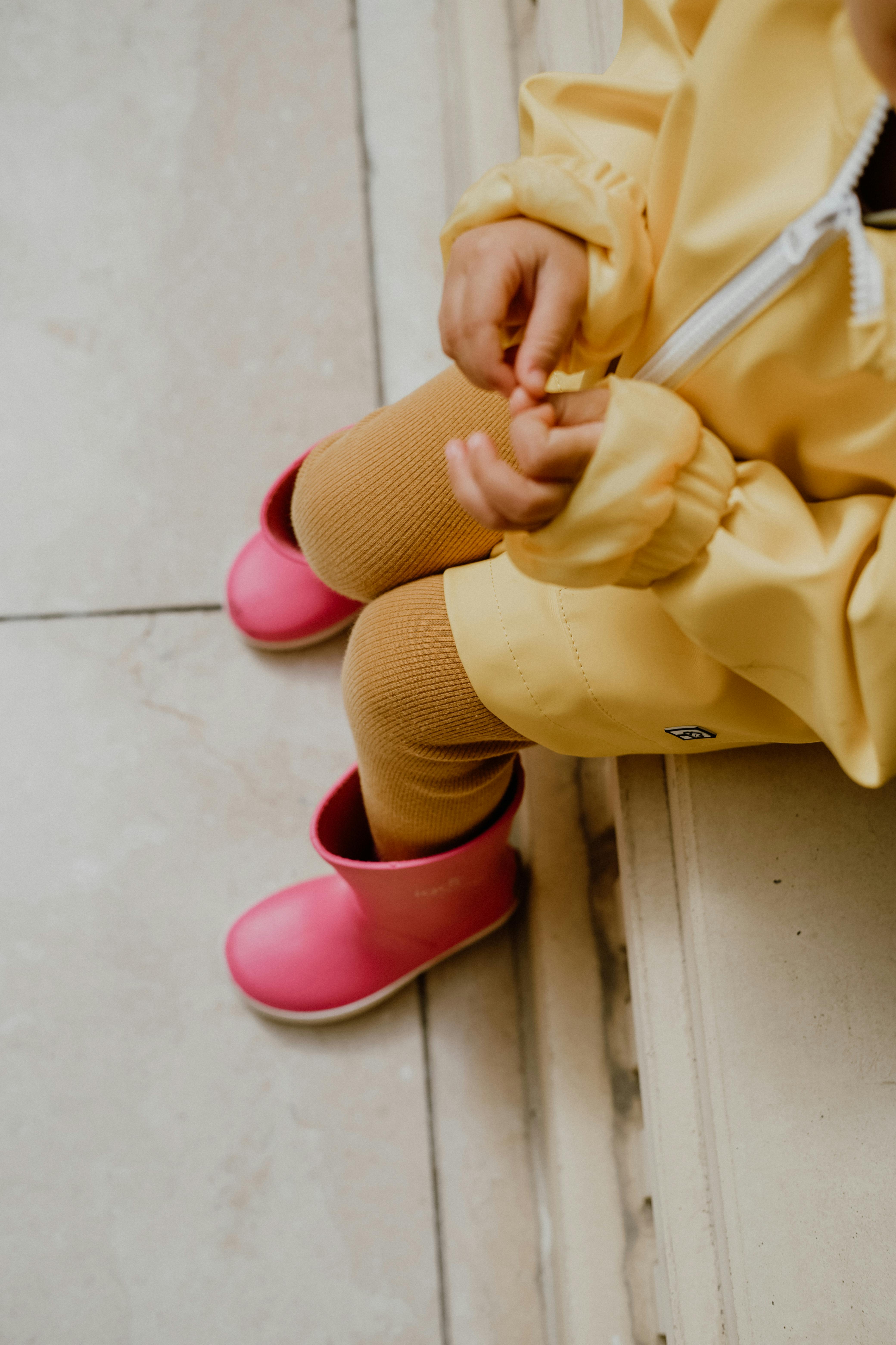 Little Girl in Pink Wellies and Yellow Raincoat · Free Stock Photo