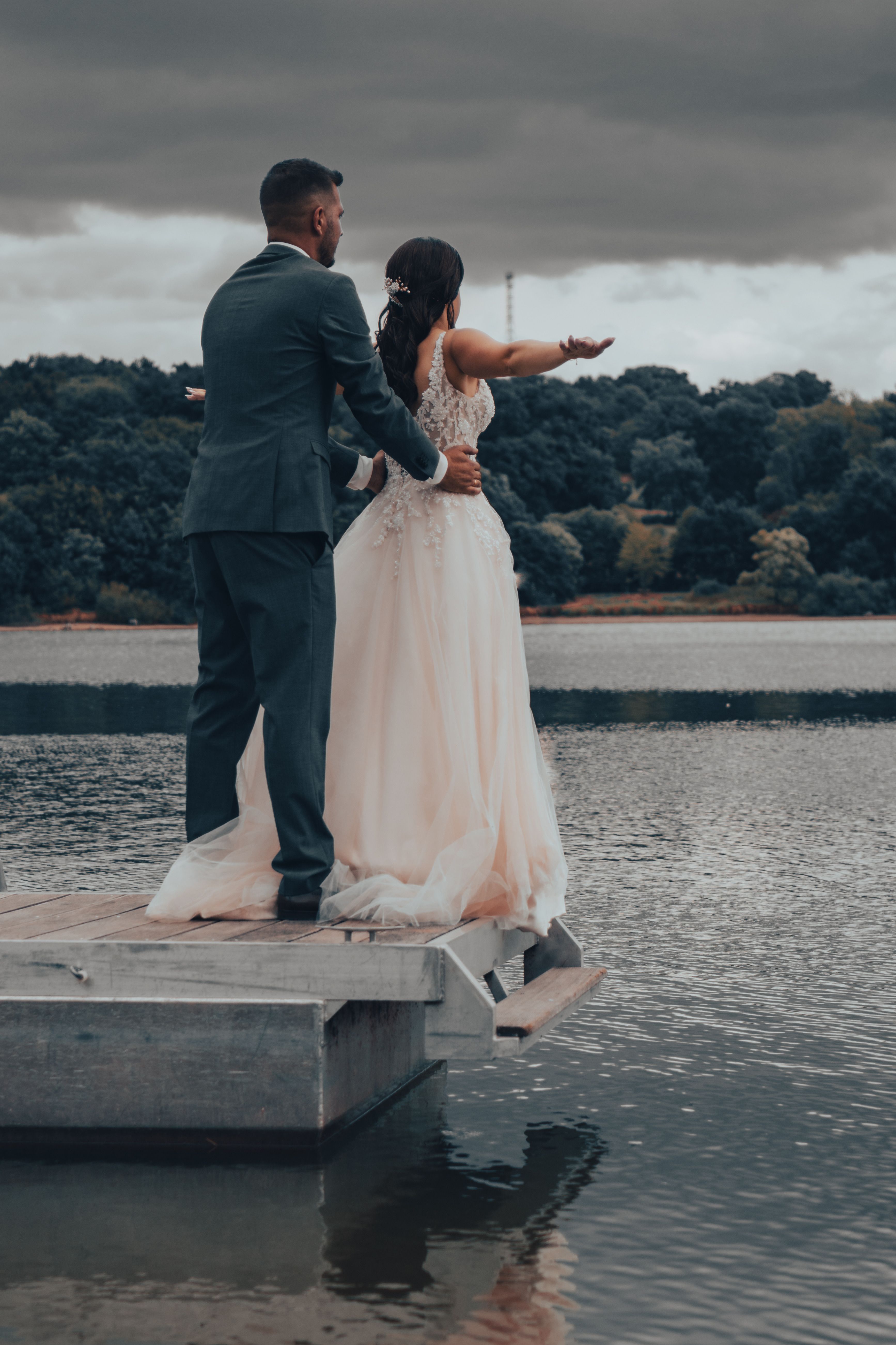 Bride and Groom Posing near Brick Building · Free Stock Photo