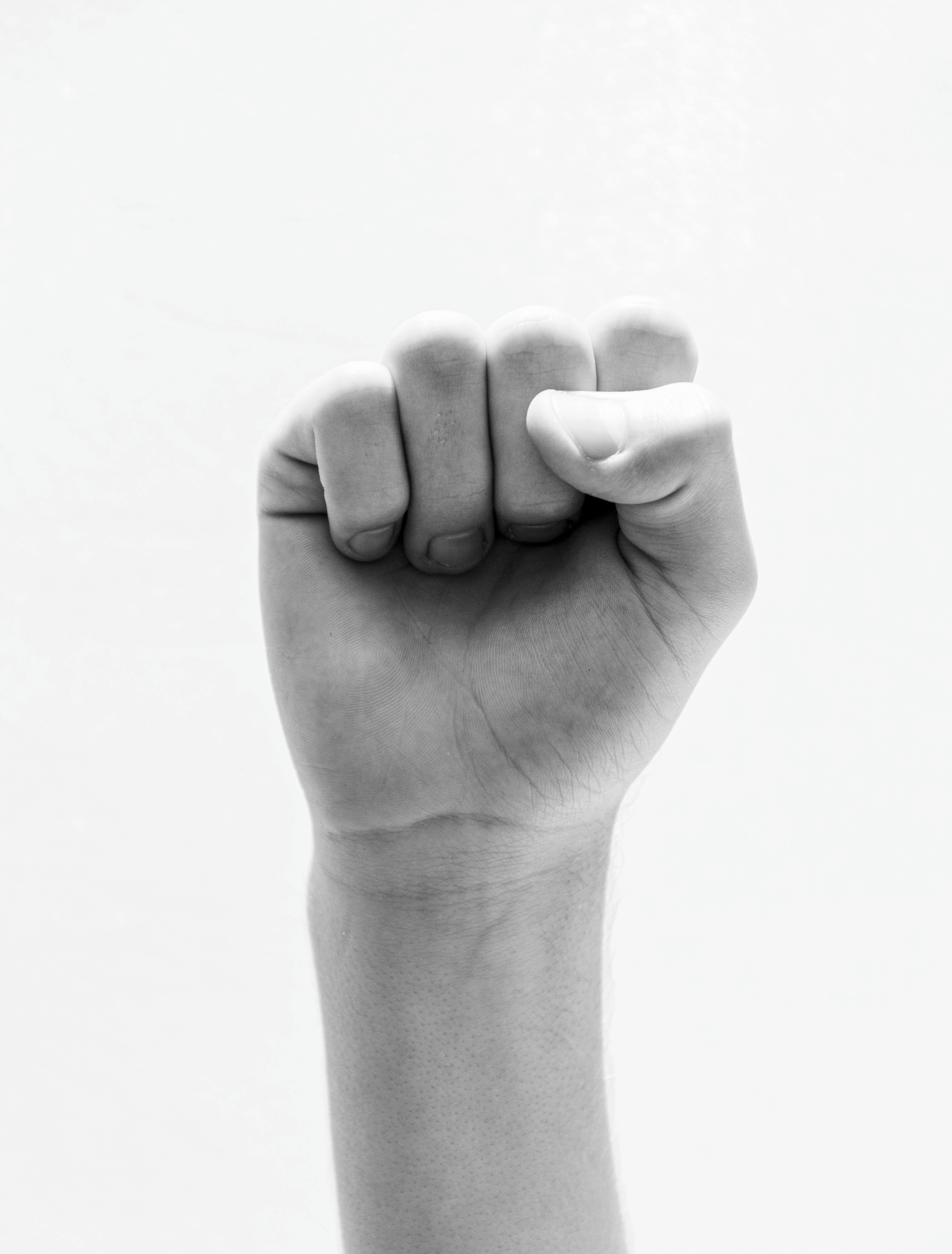 Fist Hand in Close-Up Photography · Free Stock Photo