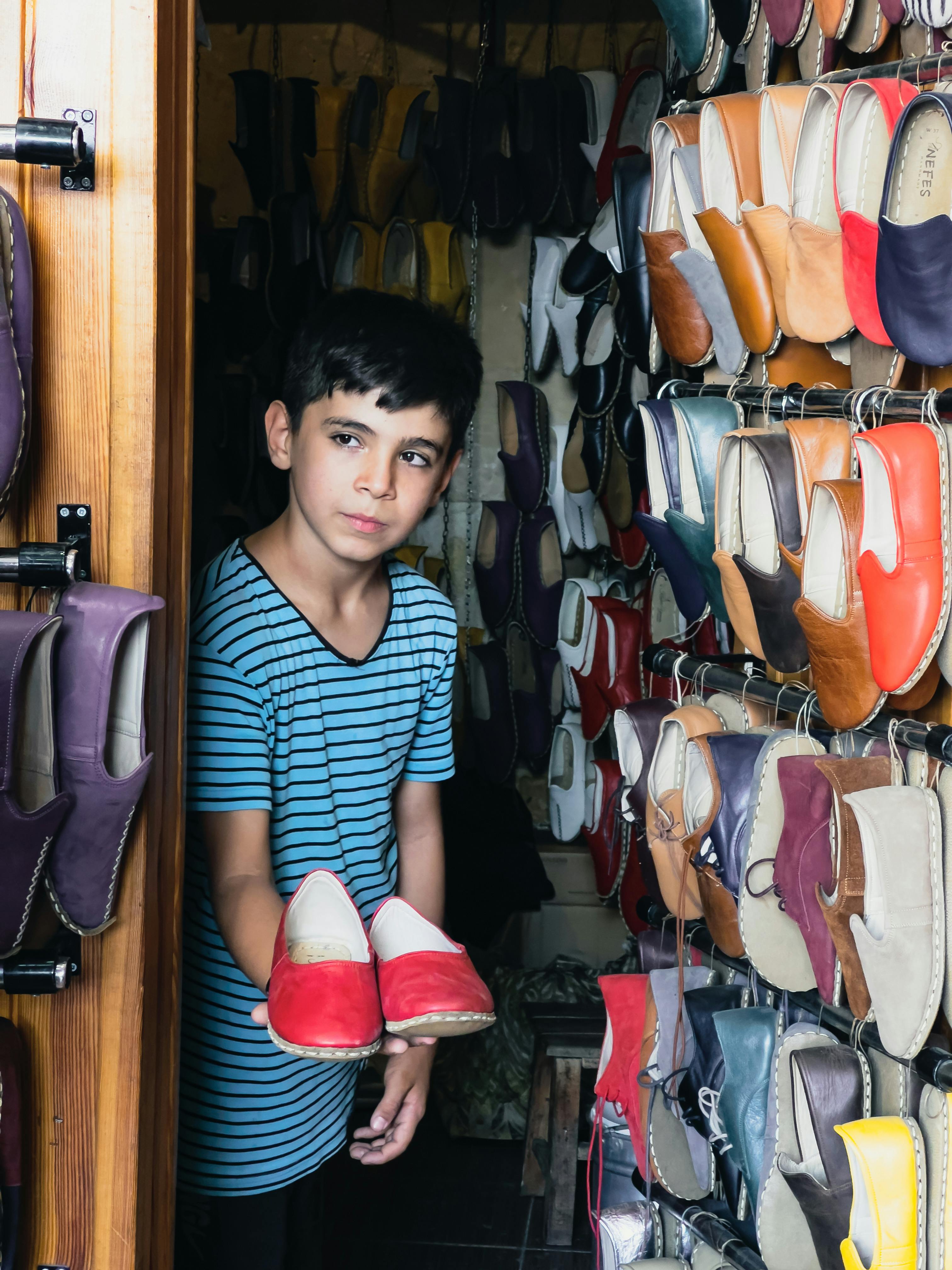 Boy Selling Shoes on Market · Free Stock Photo