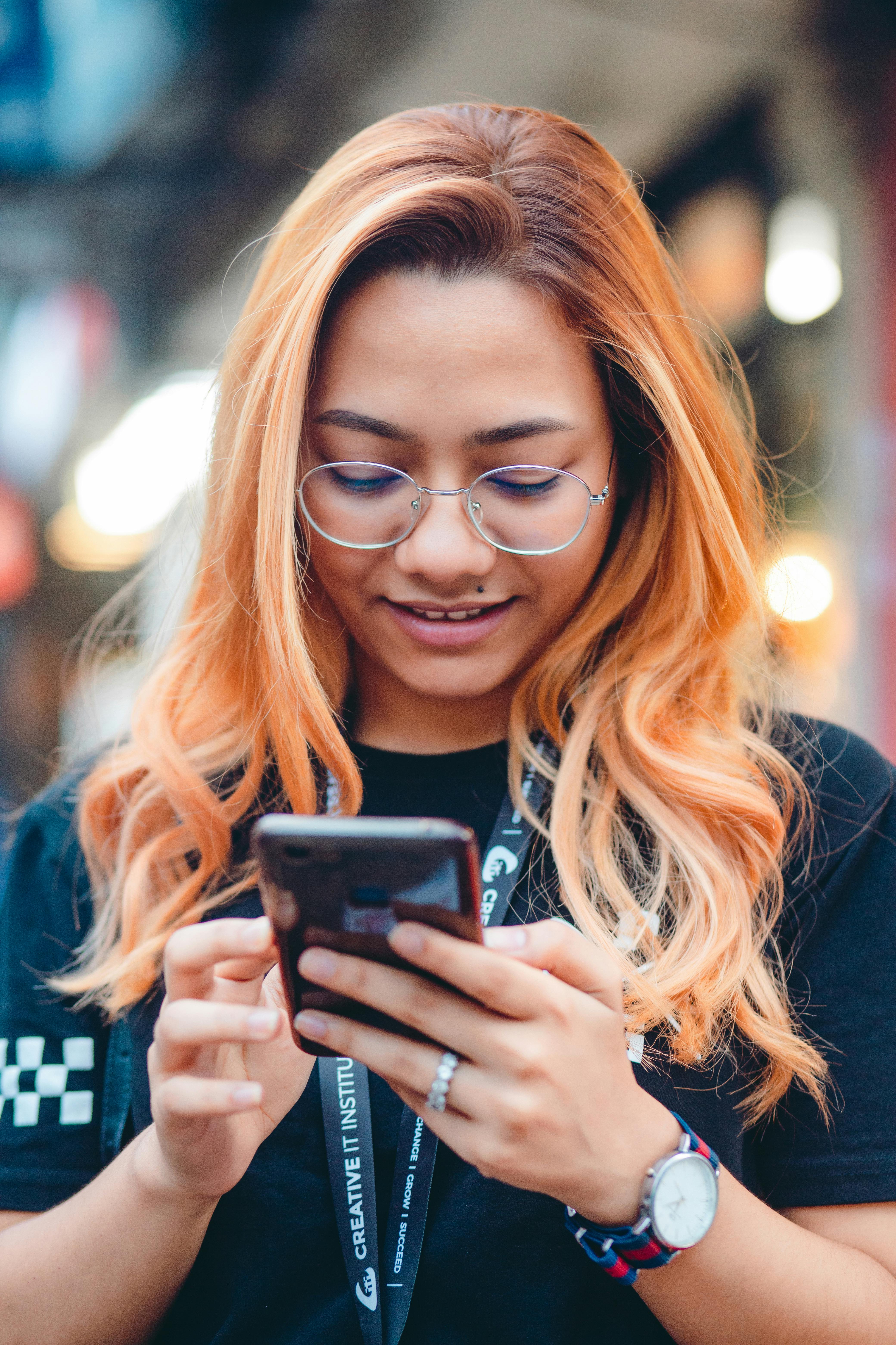 Close-Up Photo Of Woman Using Her Mobile Phone · Free Stock Photo