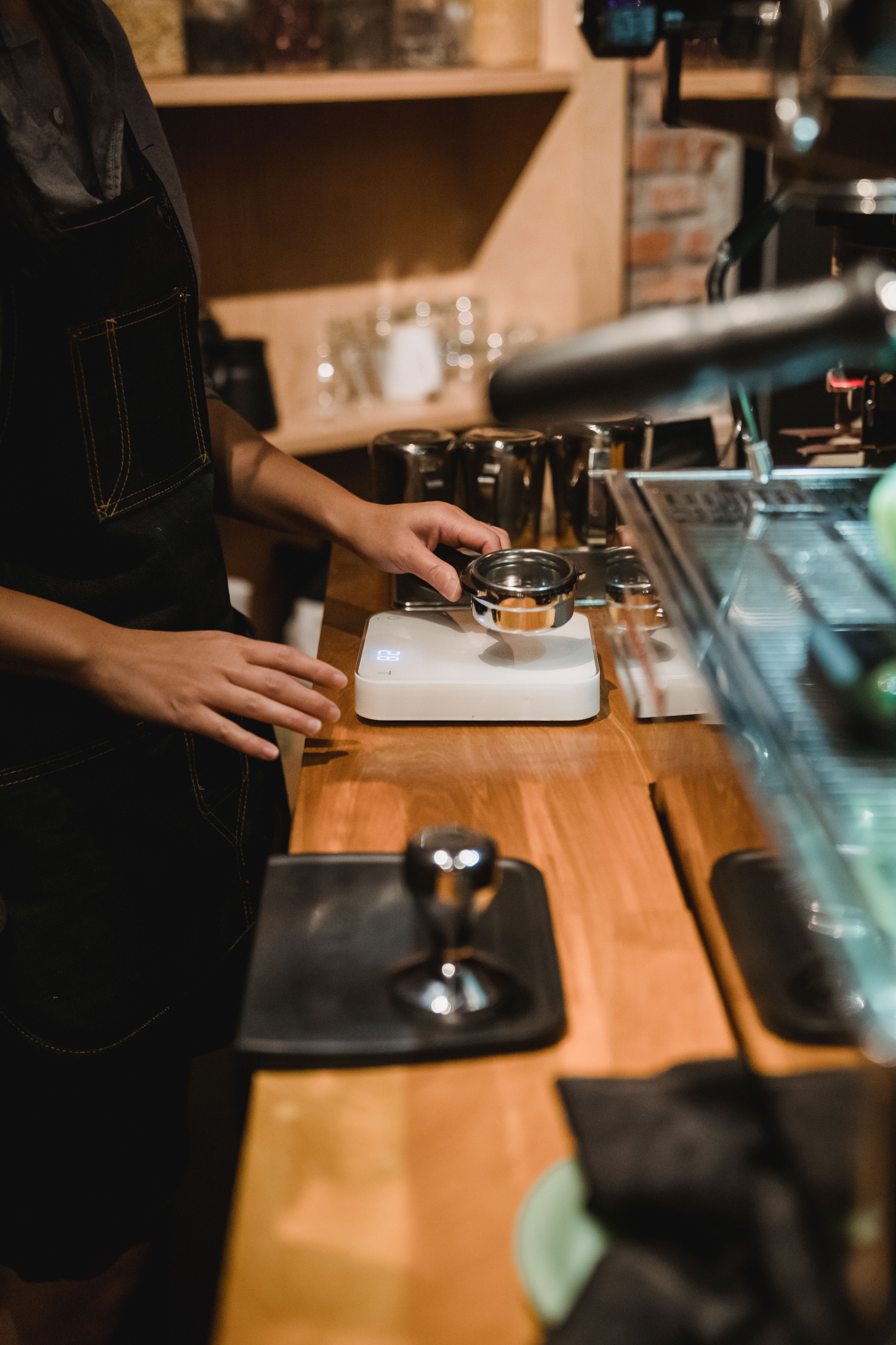 Woman Working behind Cafe Counter · Free Stock Photo