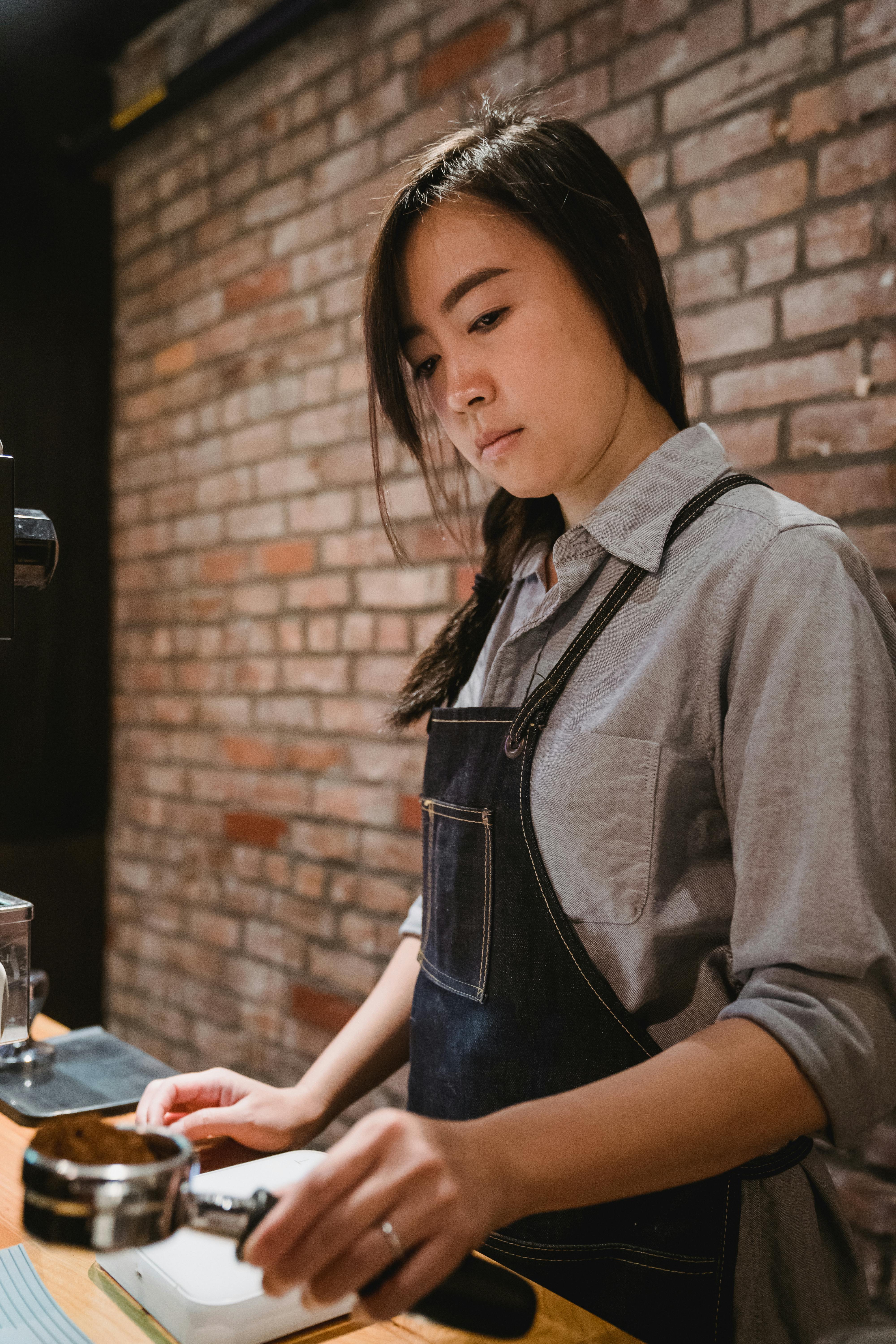 Portrait of a Woman Working at a Cafe · Free Stock Photo