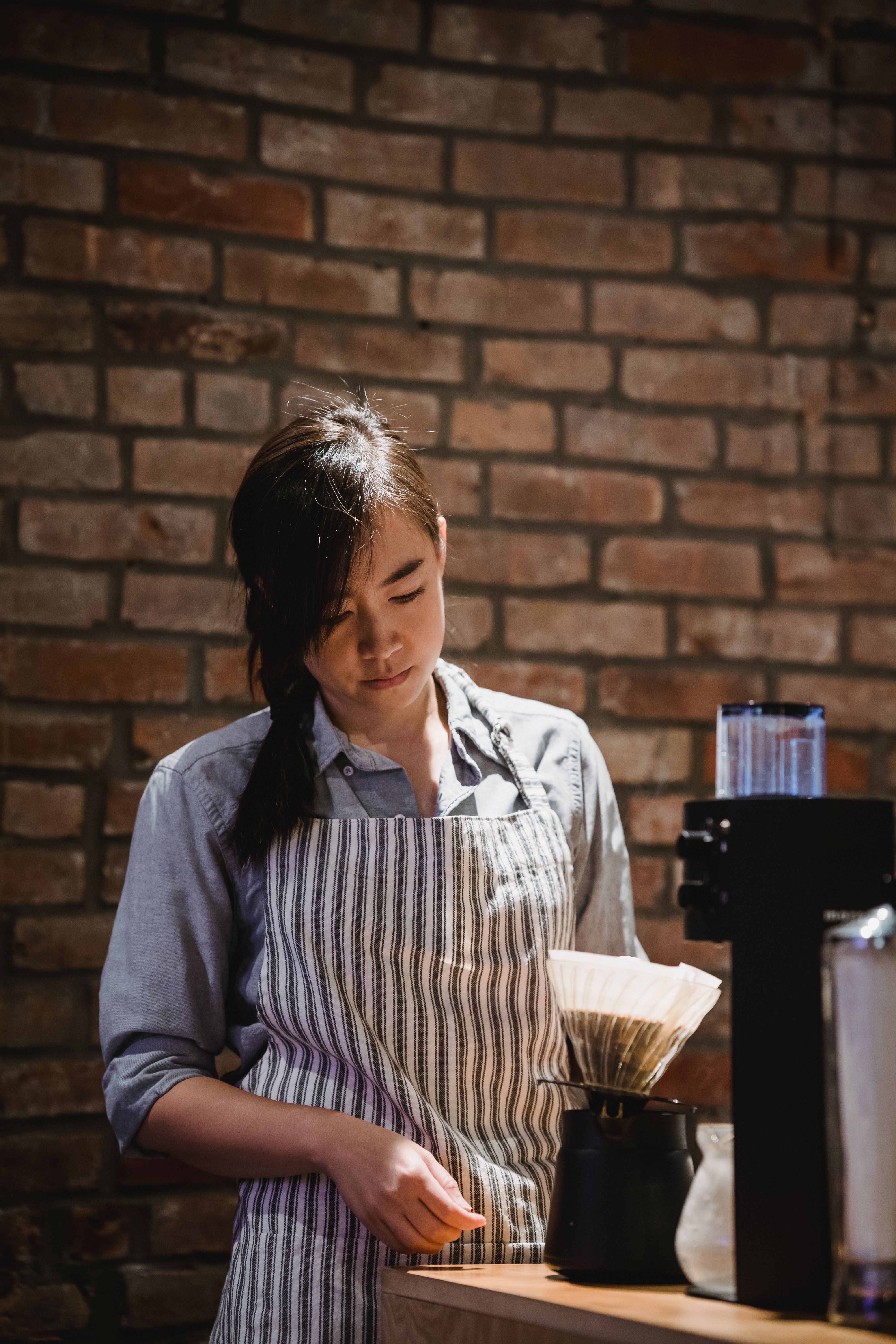 Barista Using Coffee Grinder · Free Stock Photo