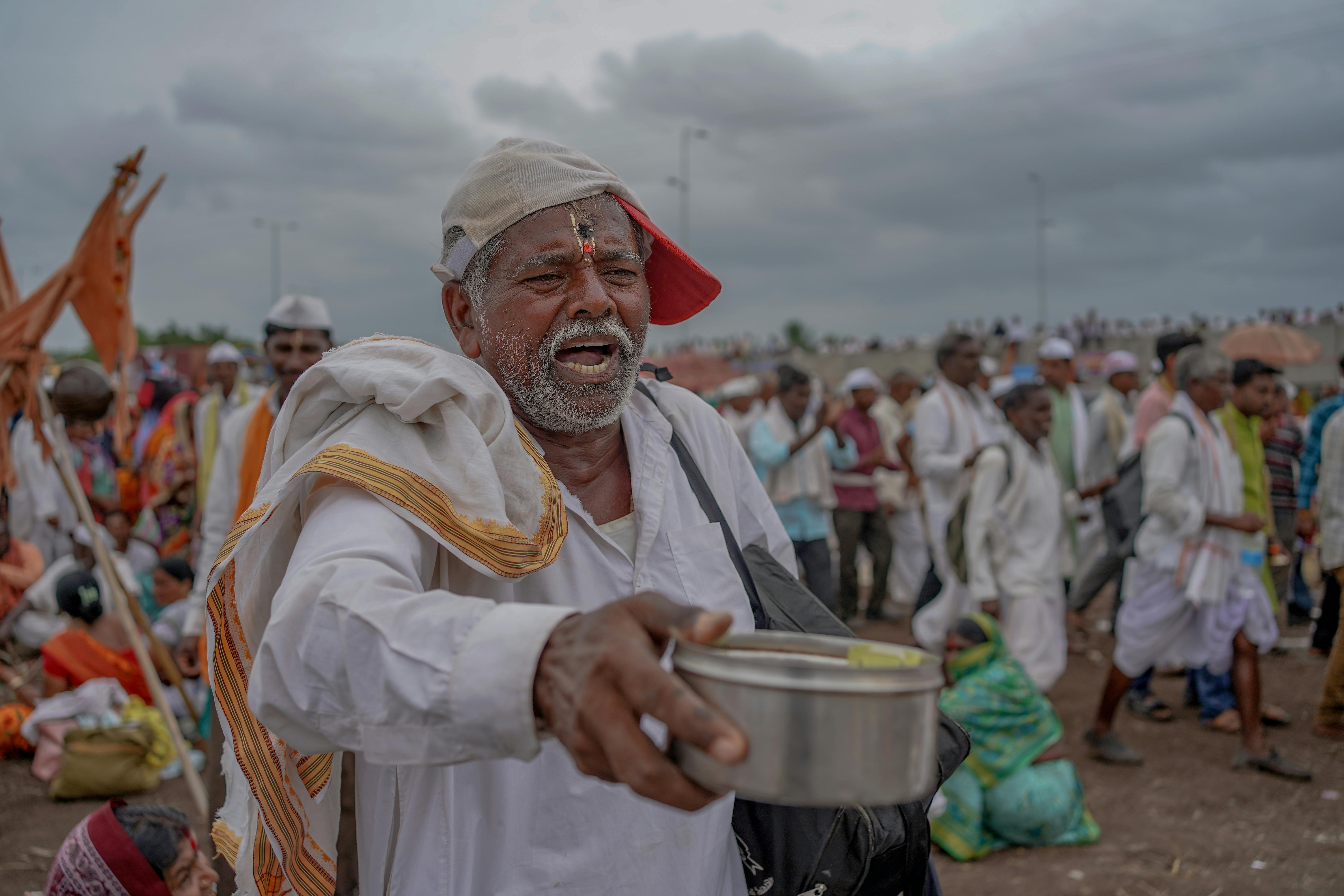 A Man in White Thobe Holding Green Plastic Bucket · Free Stock Photo