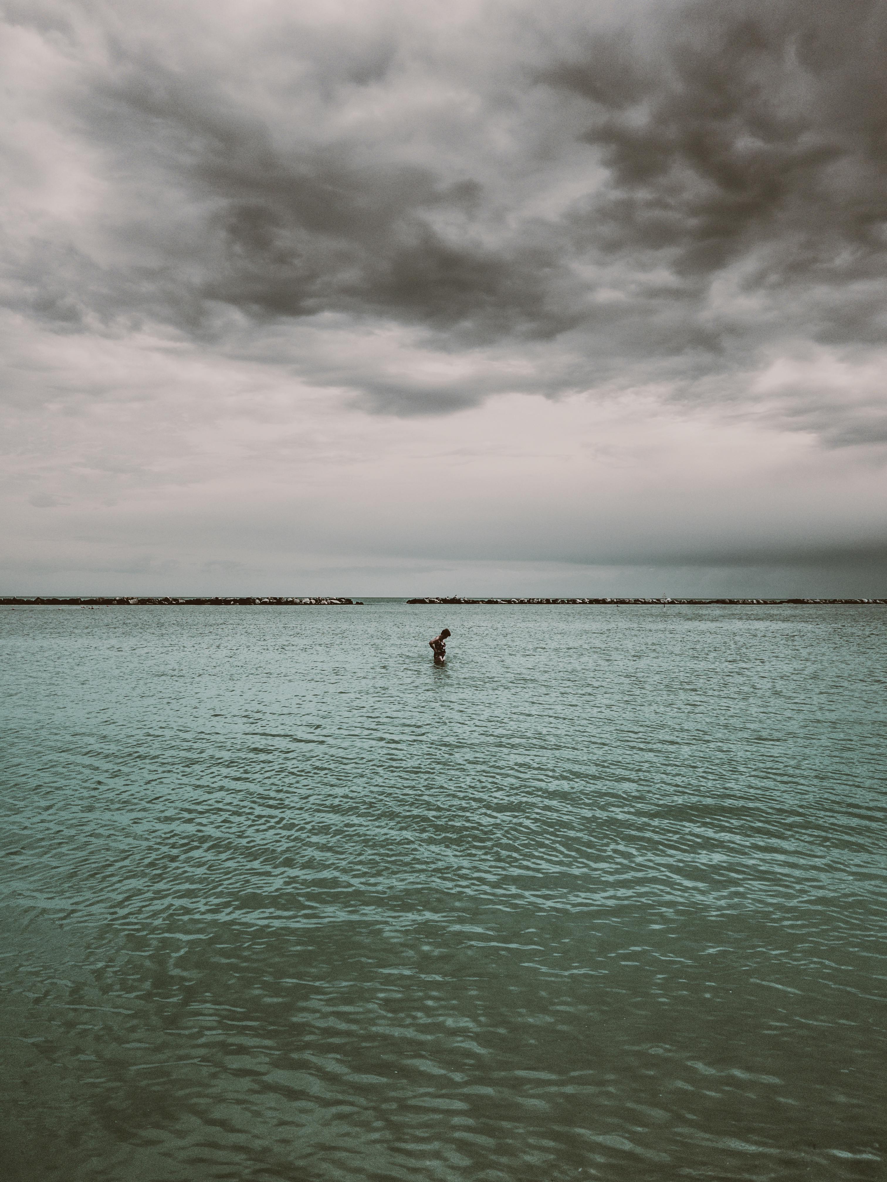 Clouds over Person in Water · Free Stock Photo