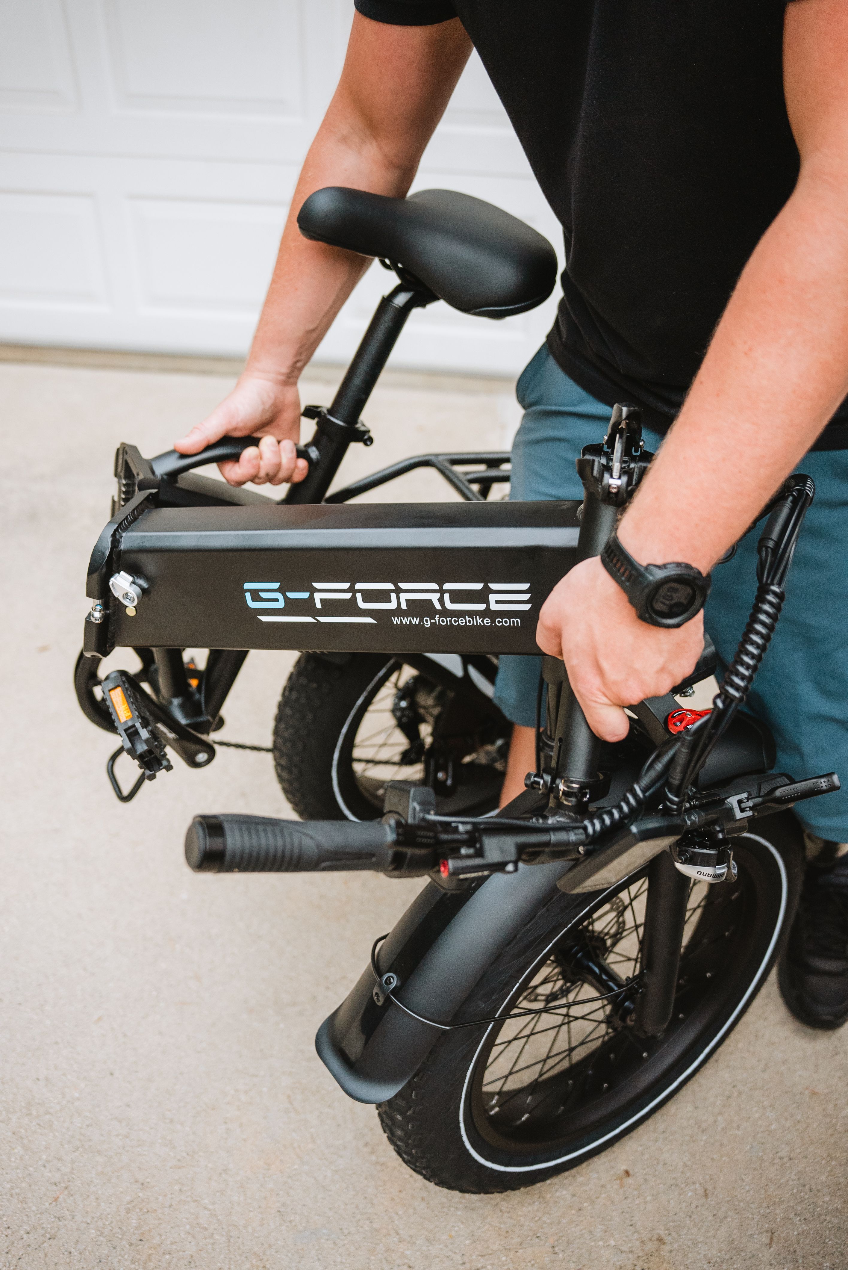 A Close-Up Shot of a Man Holding His Folding Bike · Free Stock Photo