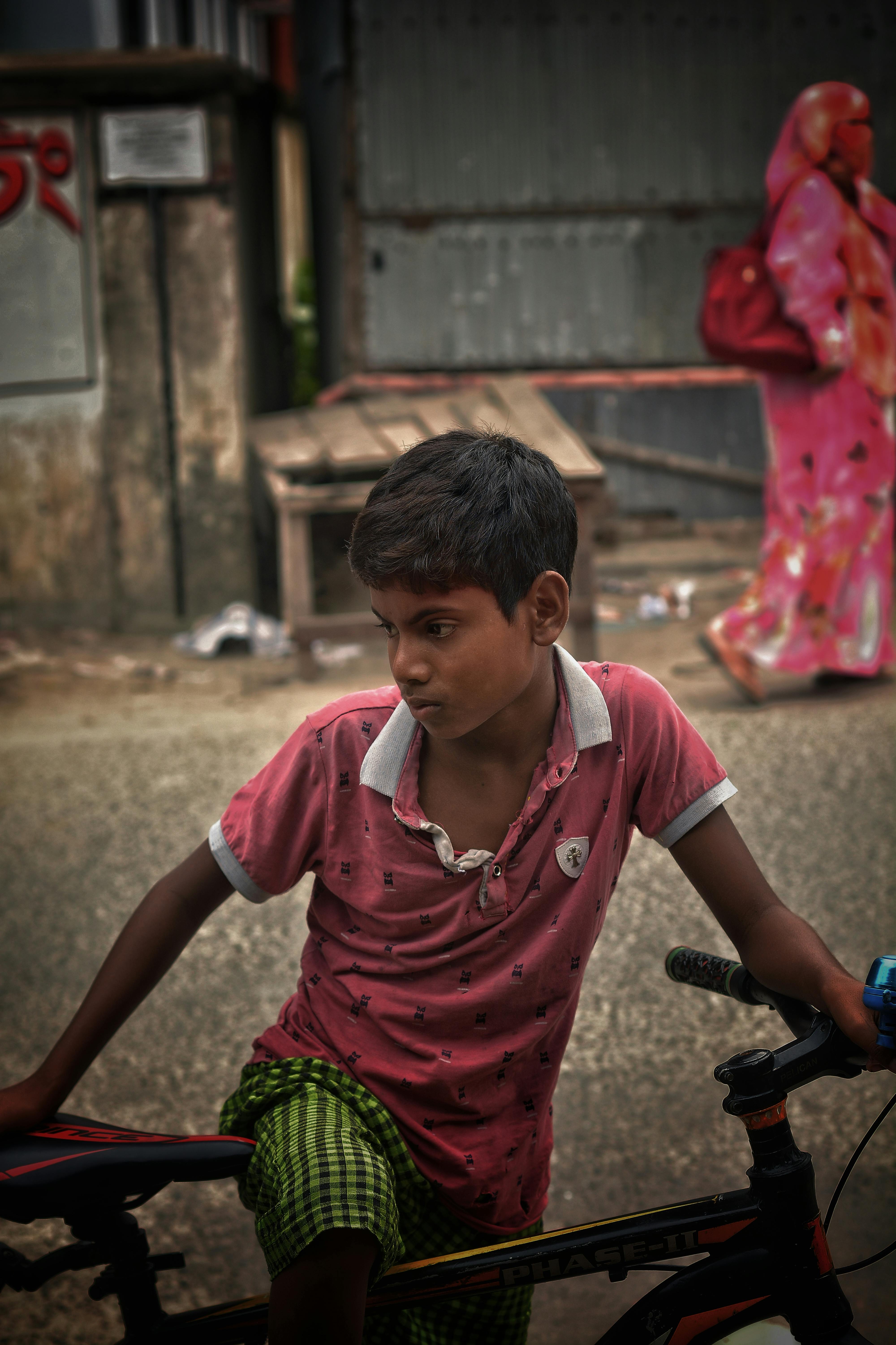 Boy Holding a Bicycle · Free Stock Photo