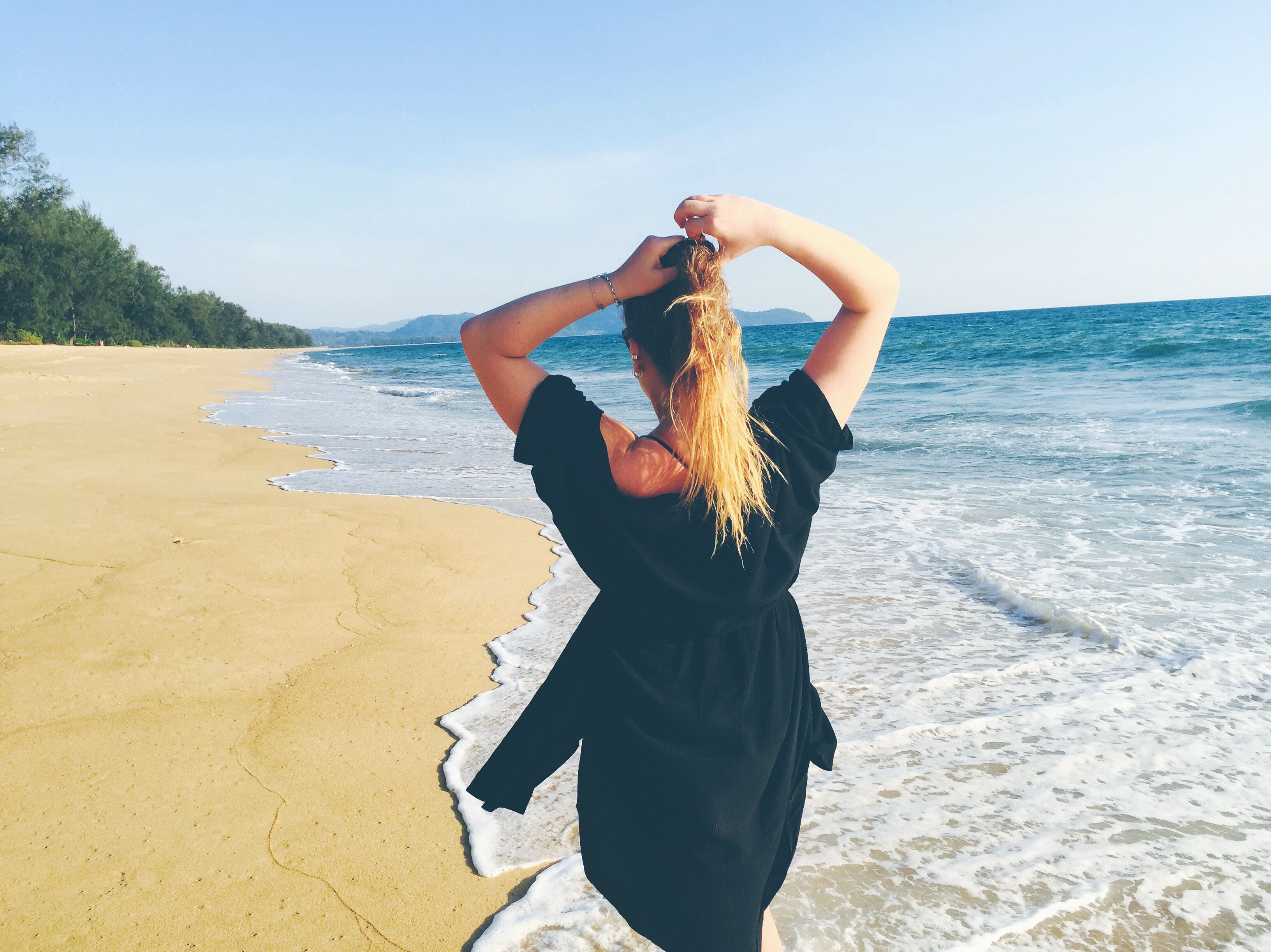 Woman Standing on Sea Shore · Free Stock Photo