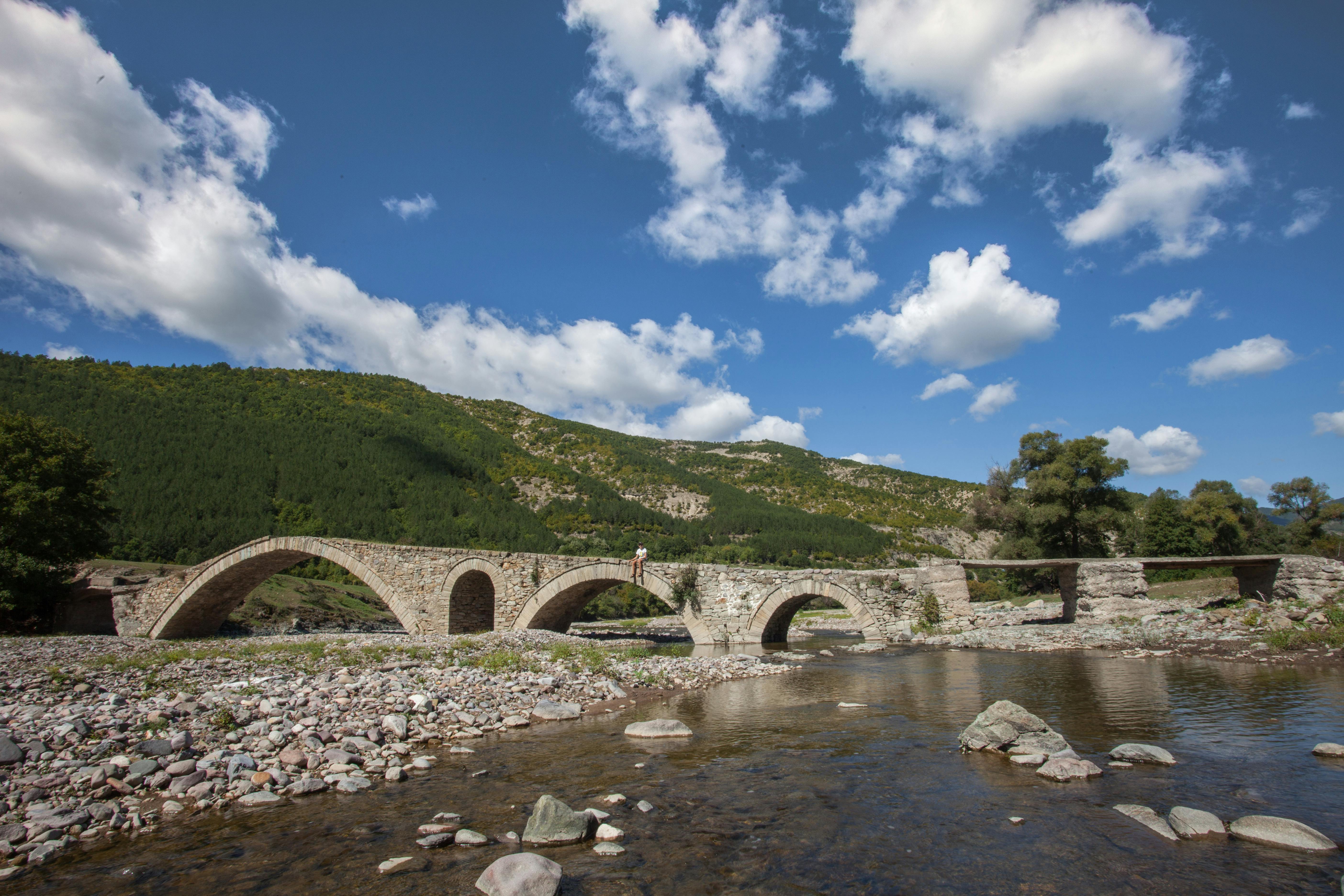 Old Bridge over River in Open Field · Free Stock Photo