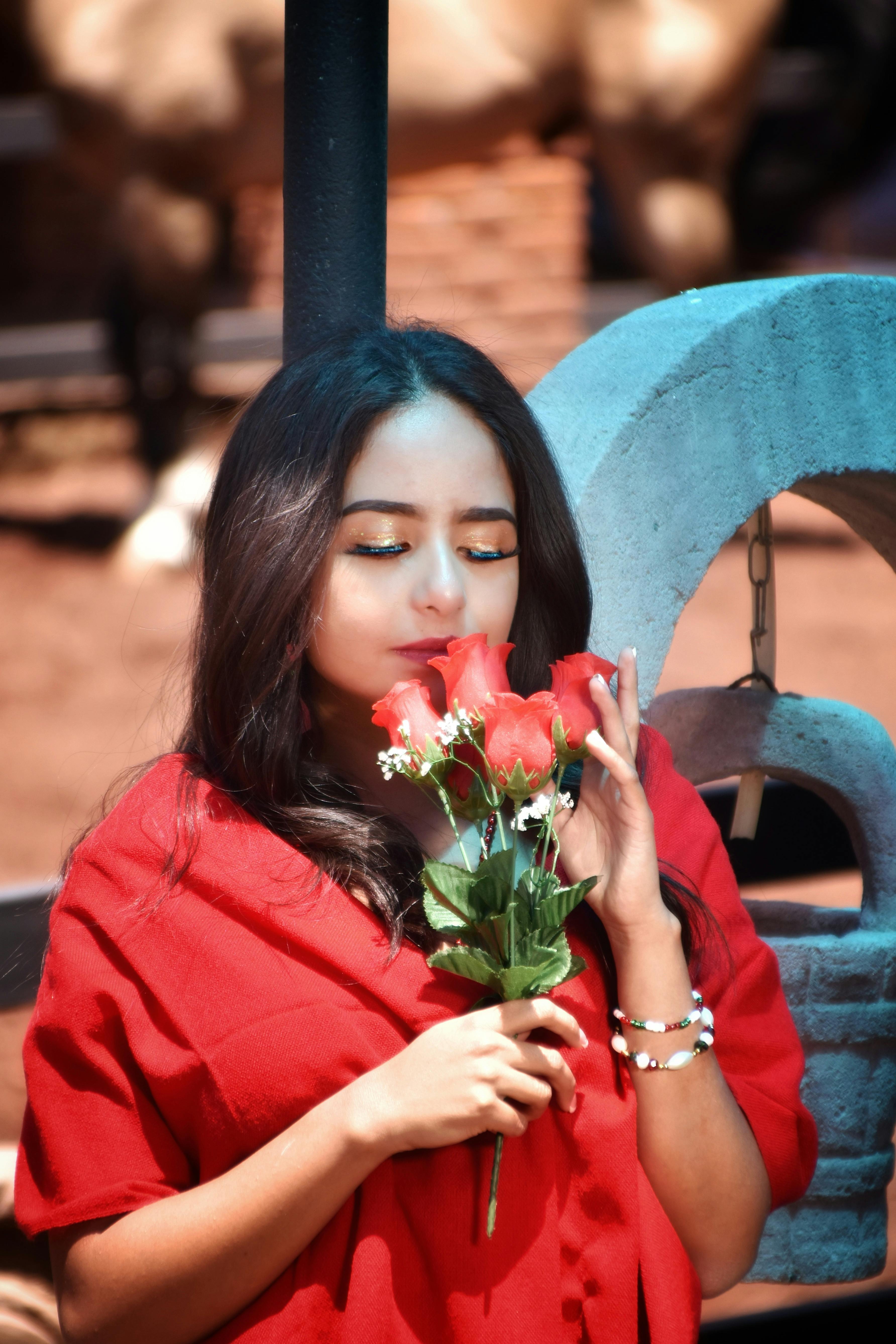 Woman in Red Long Sleeve Shirt Holding Red Roses · Free Stock Photo