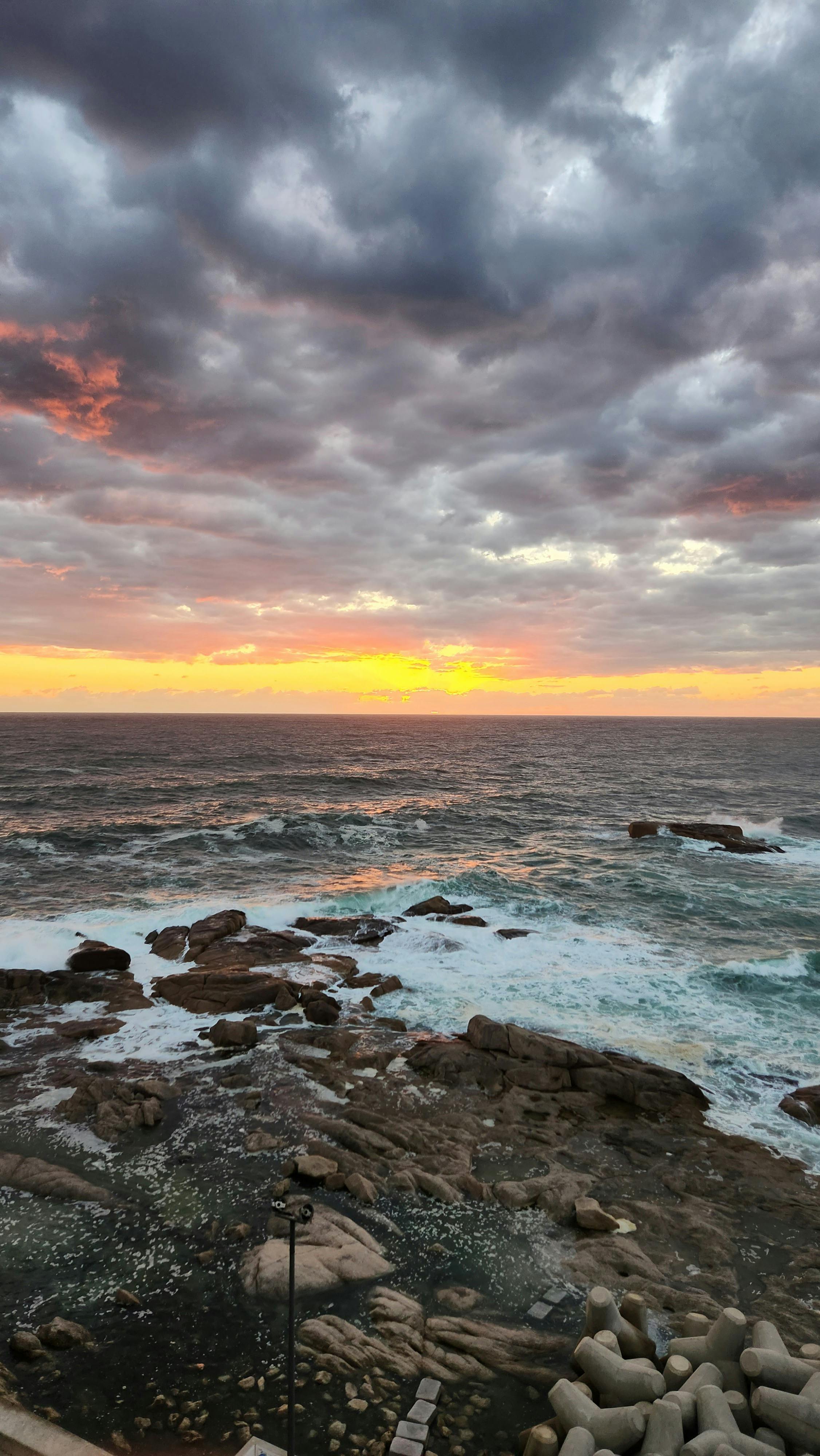 Sea Waves Crashing on Rocks during Sunset · Free Stock Photo
