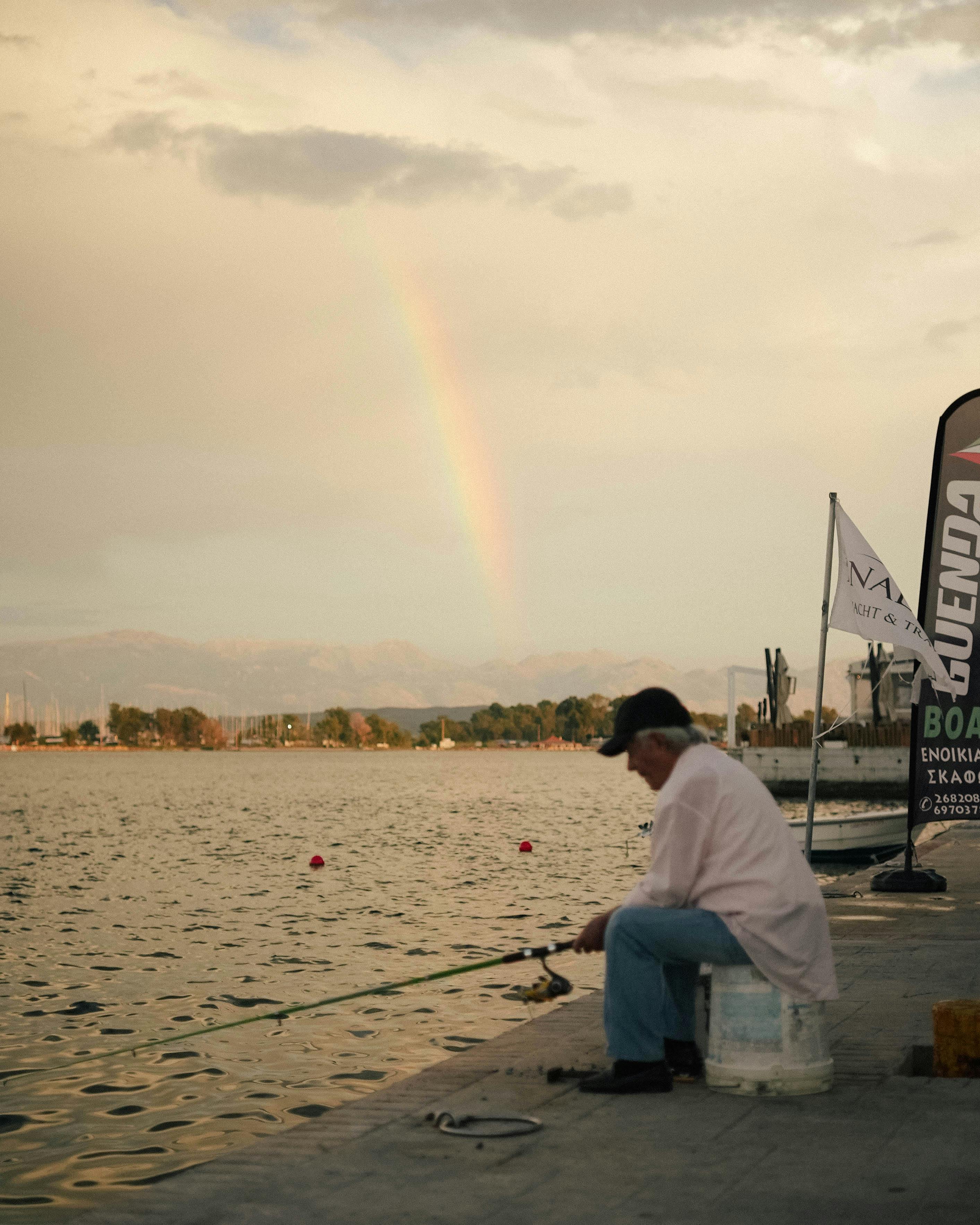 Man Fishing on Lakeshore · Free Stock Photo