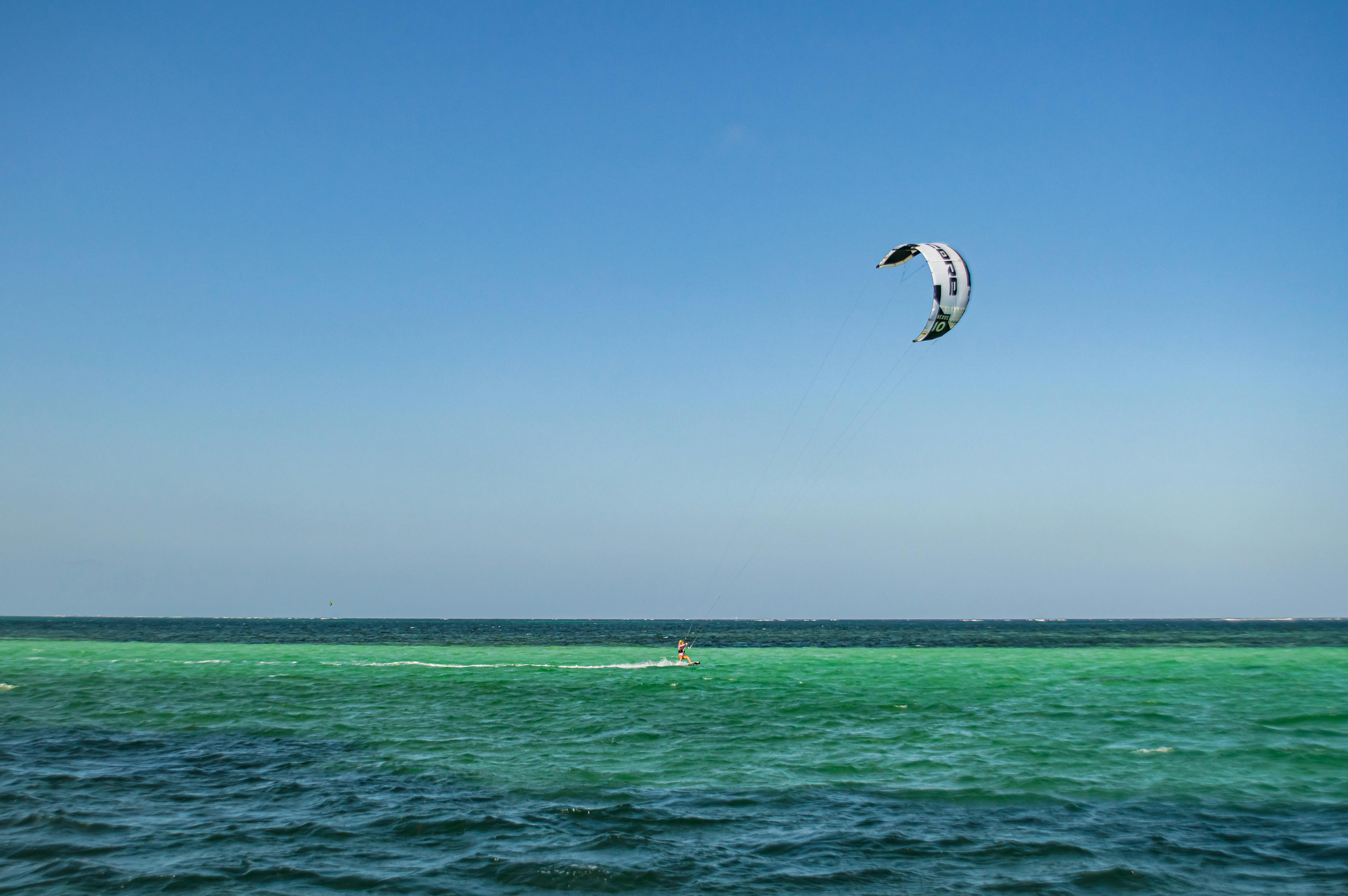 Person on Body of Water Kitesurfing · Free Stock Photo
