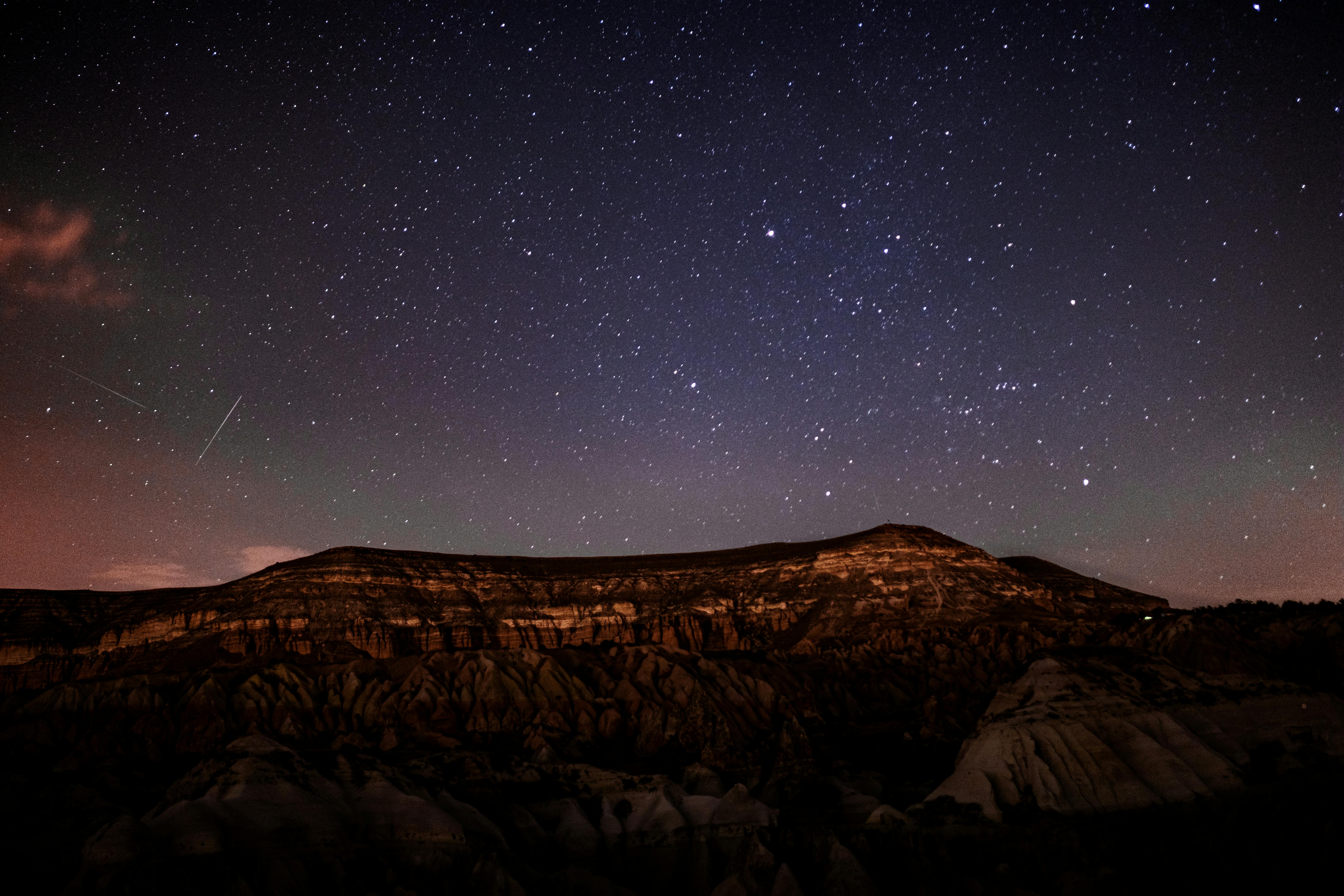 Vehicles Parked Near A Cliff Under A Starry Sky · Free Stock Photo
