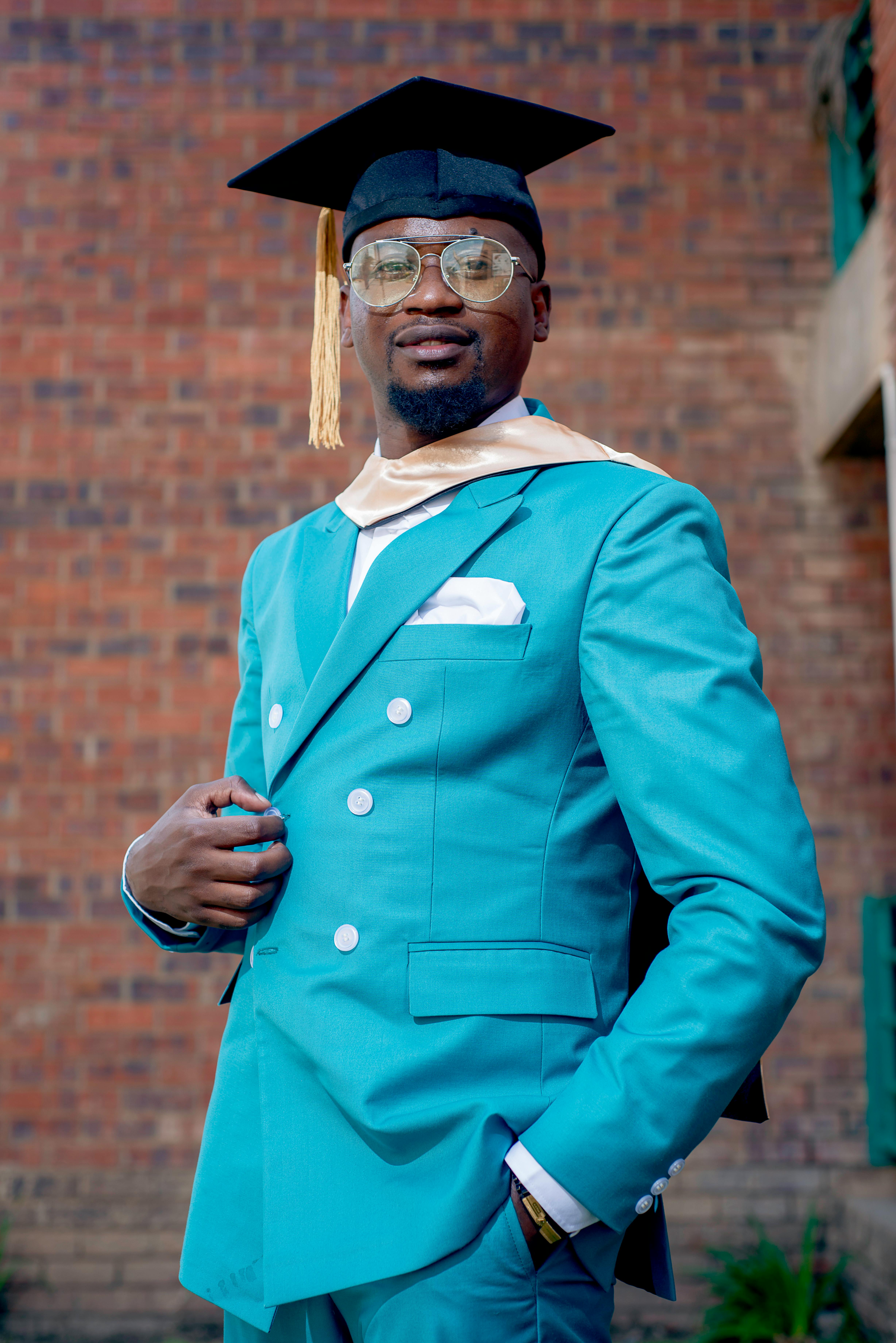 Graduate in Blue Suit and Academic Hat · Free Stock Photo