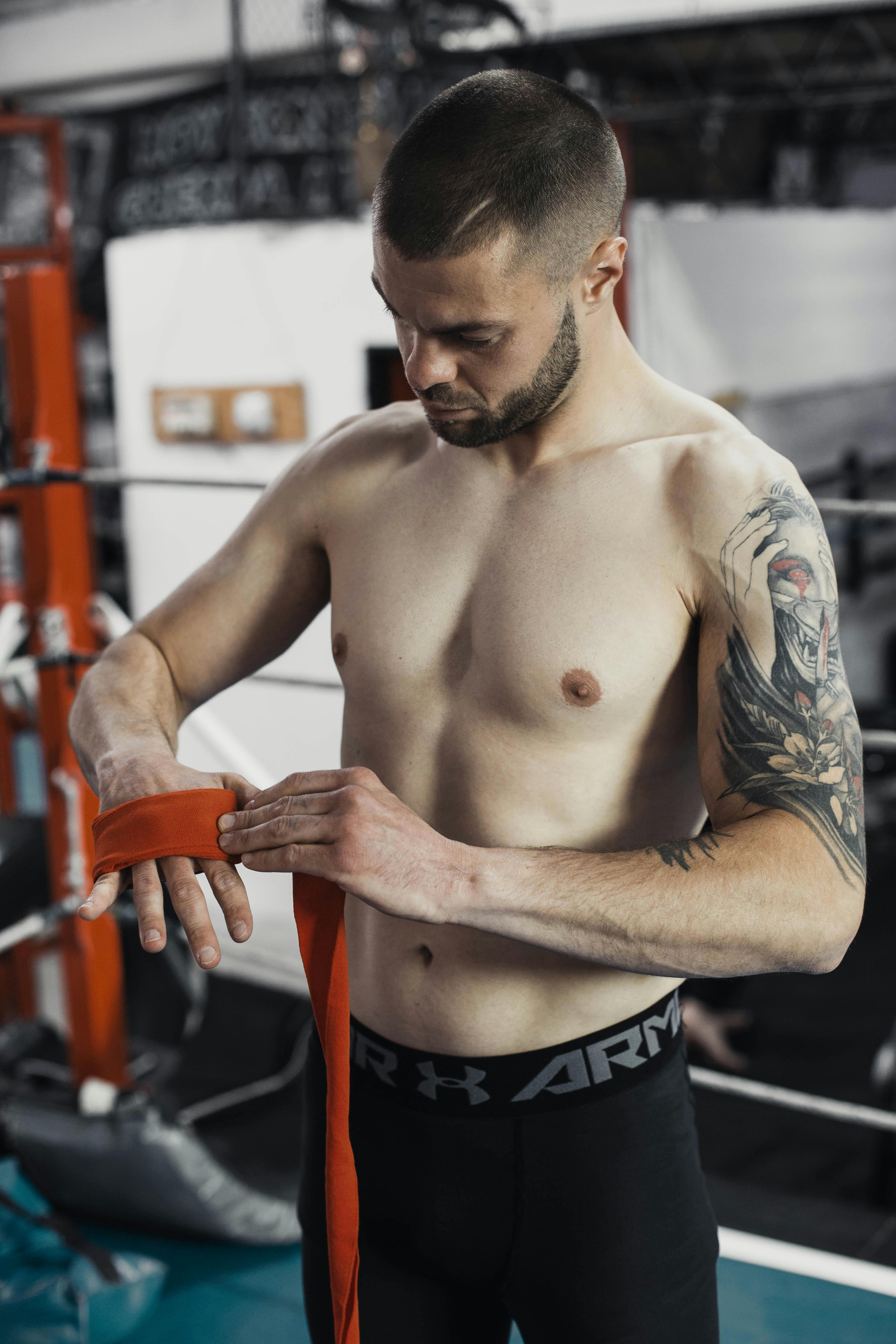 Close up of Man Standing with Tape in Boxing Ring · Free Stock Photo