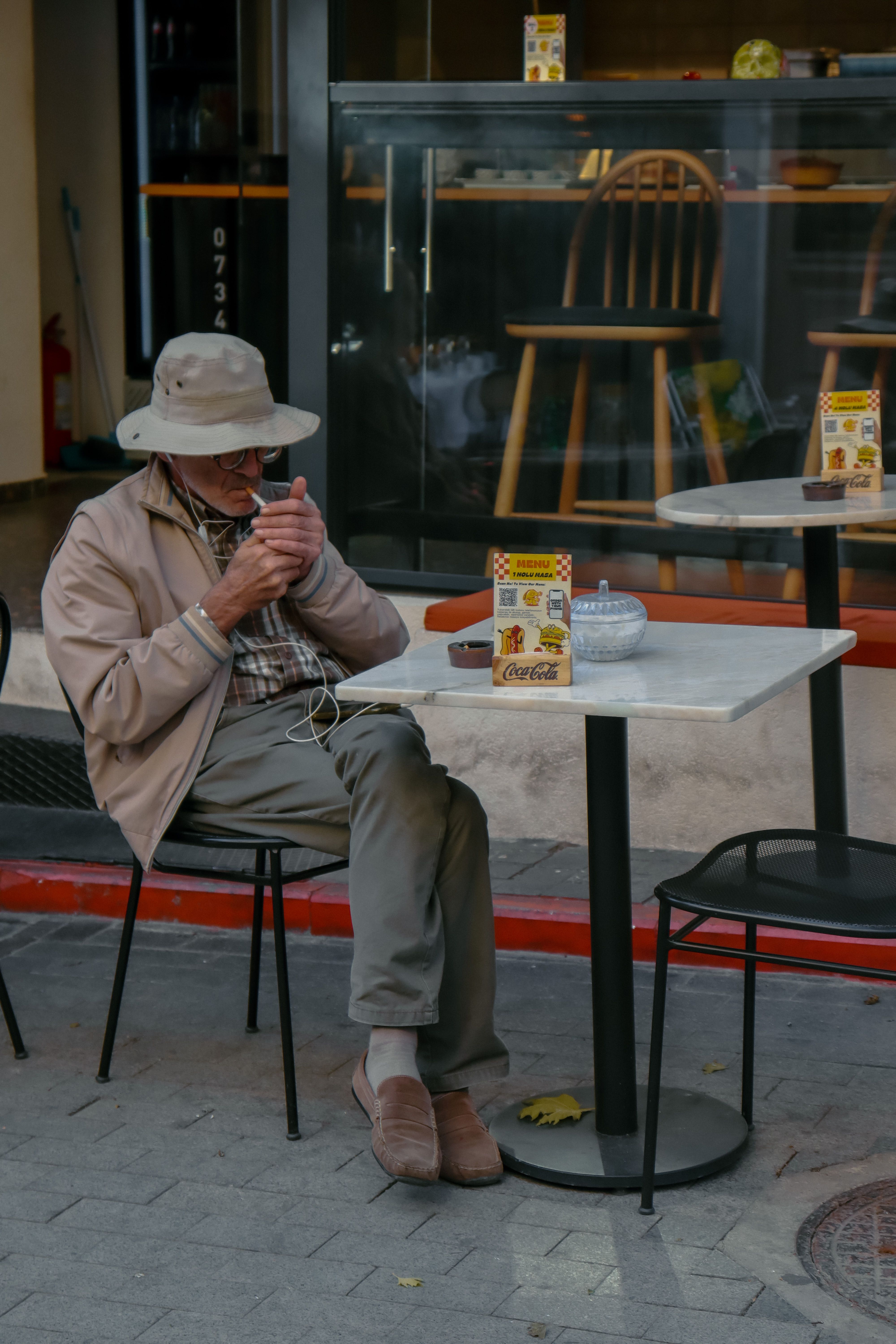 A Woman Smoking while Sitting on a Chair · Free Stock Photo