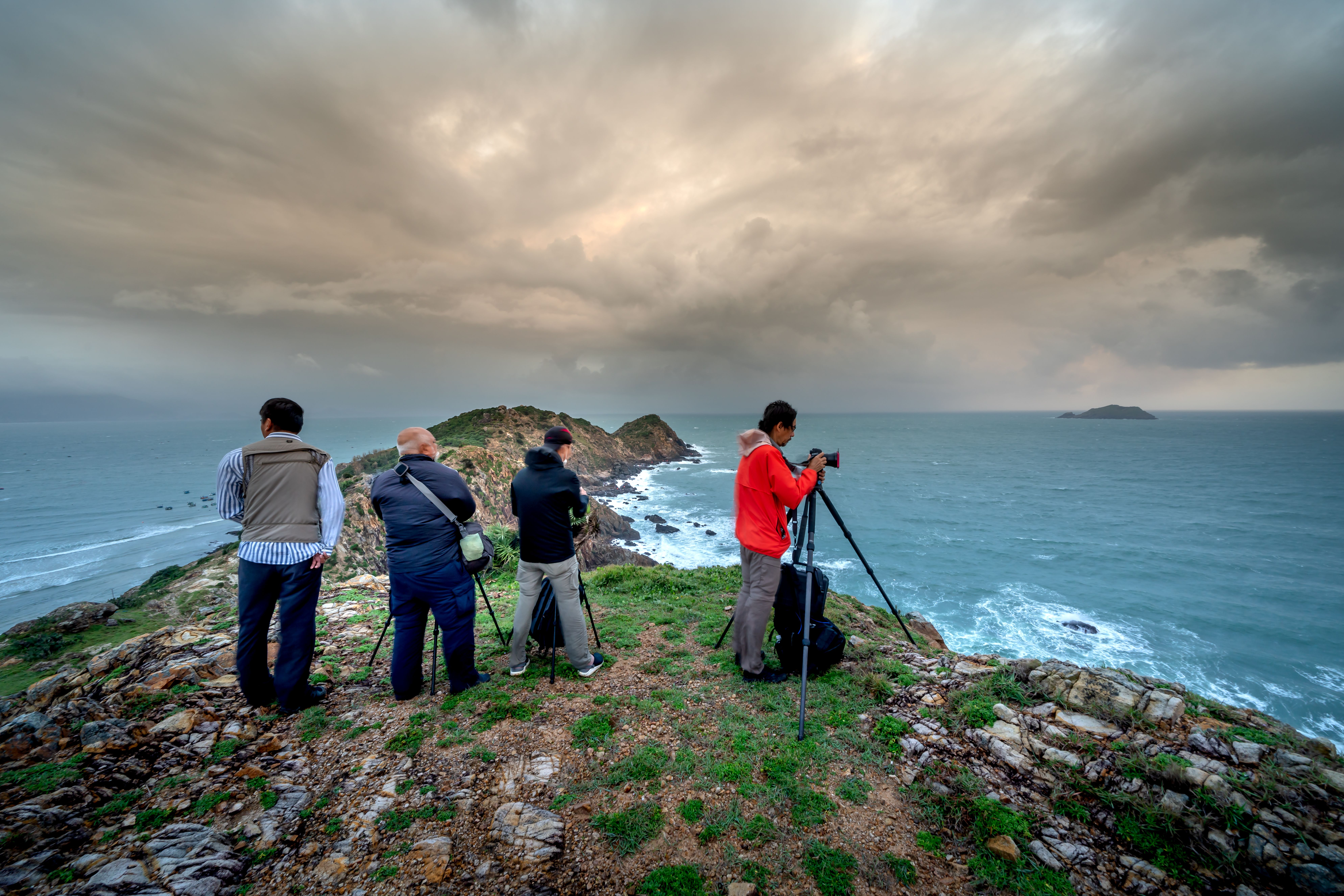 Photographers on Sea Shore under Clouds · Free Stock Photo