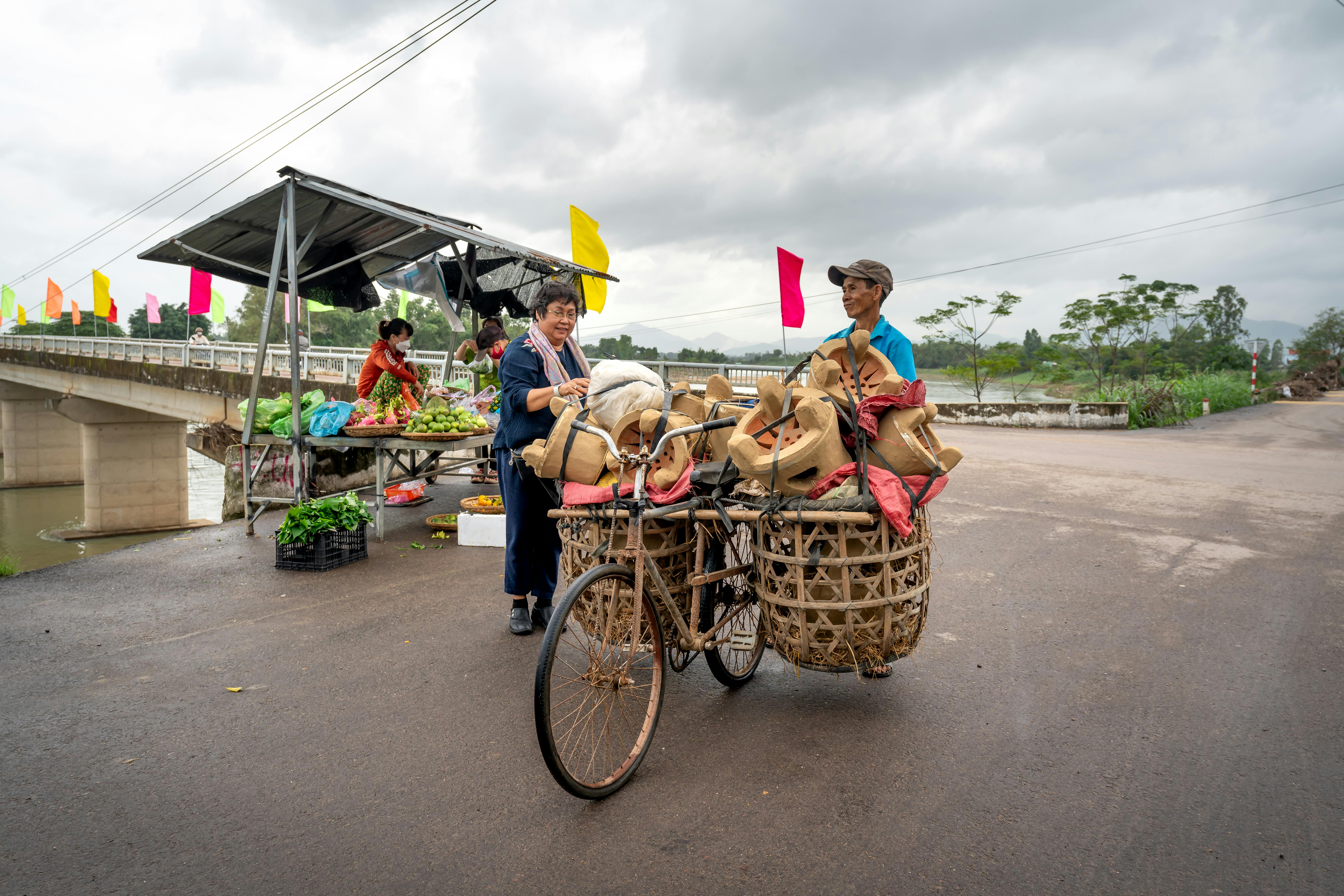 People Transporting Items in Baskets on a Bicycle · Free Stock Photo