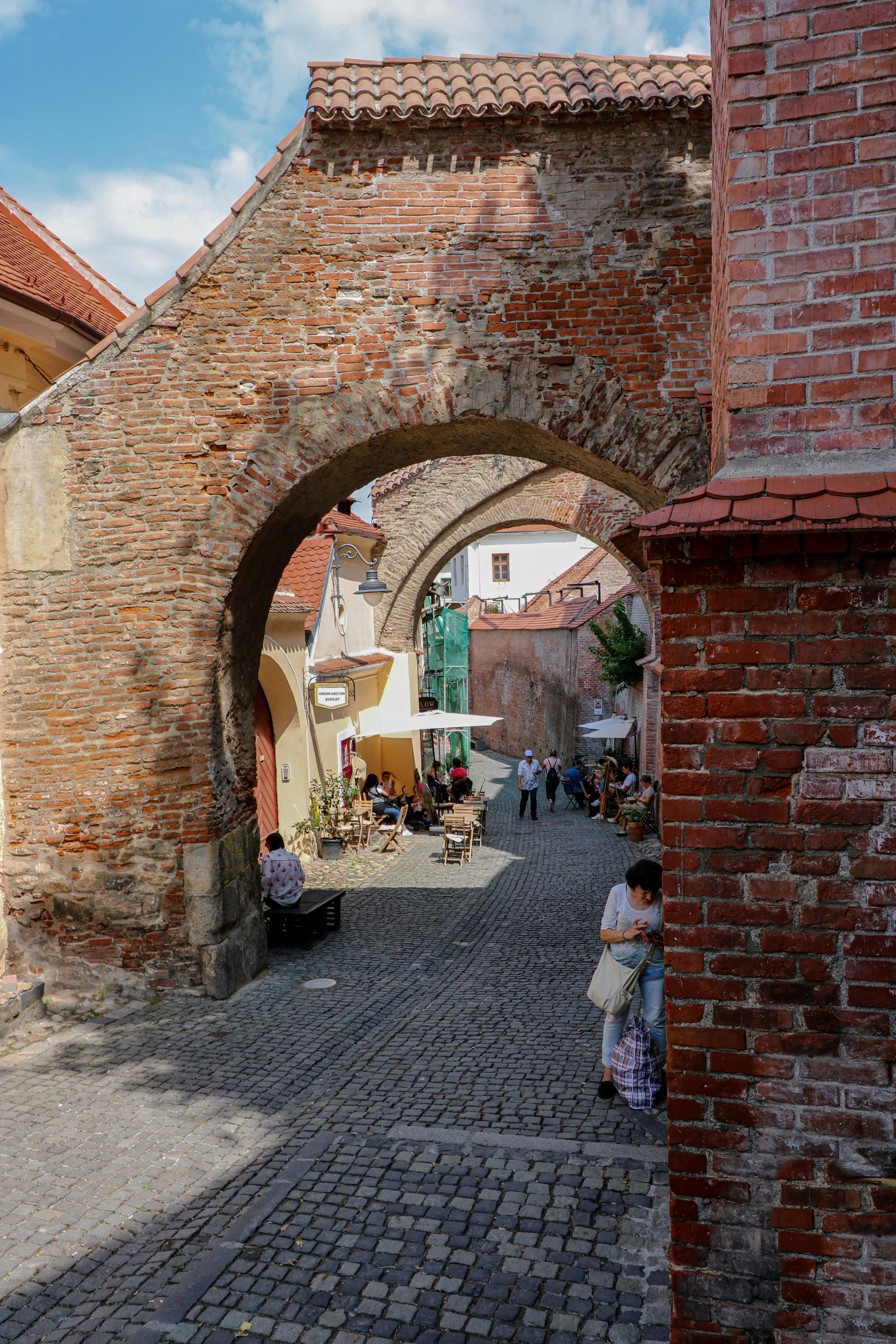 Arch over Cobblestone Street in Town · Free Stock Photo