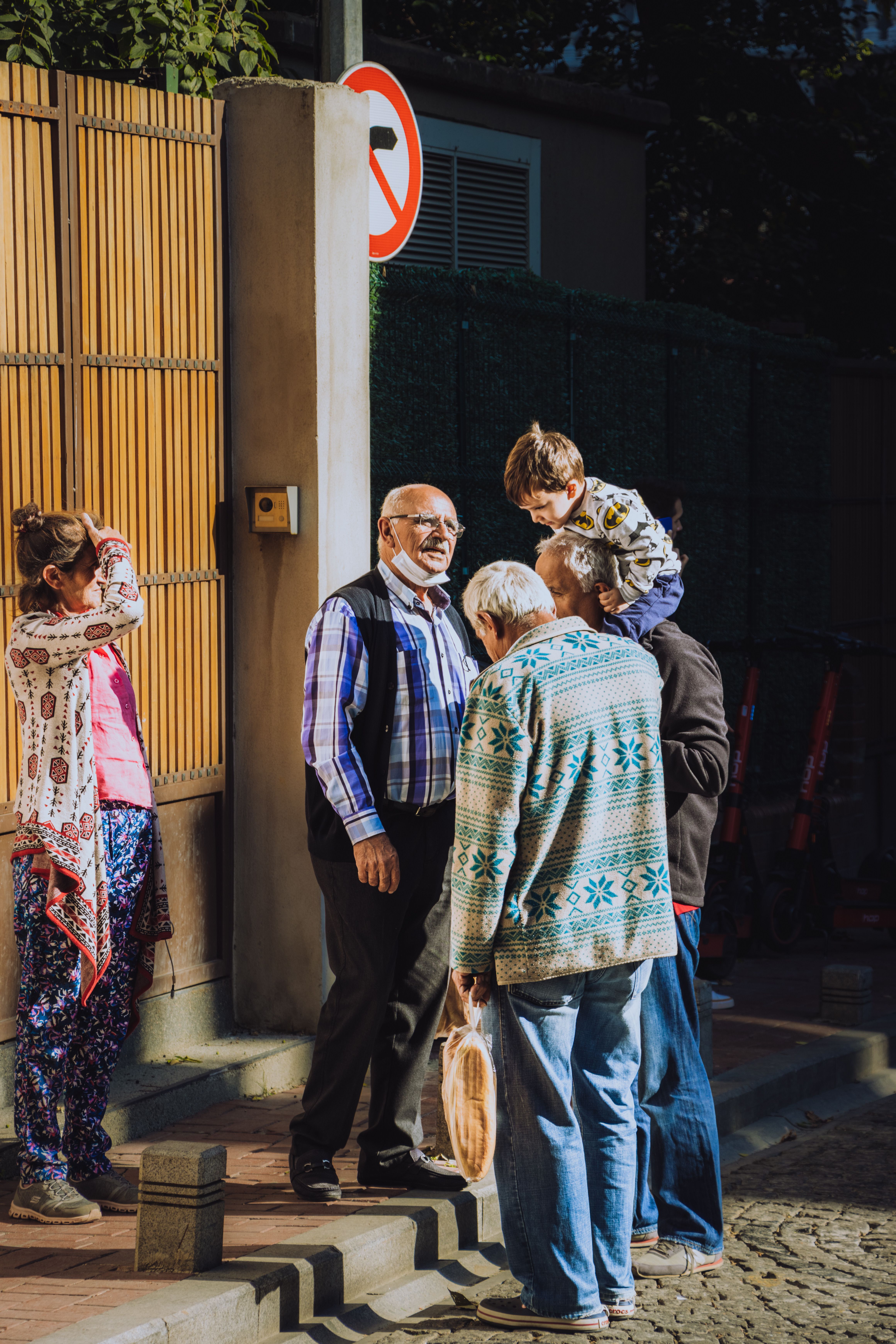 People Standing on Street beside Brown Wooden Fence · Free Stock Photo