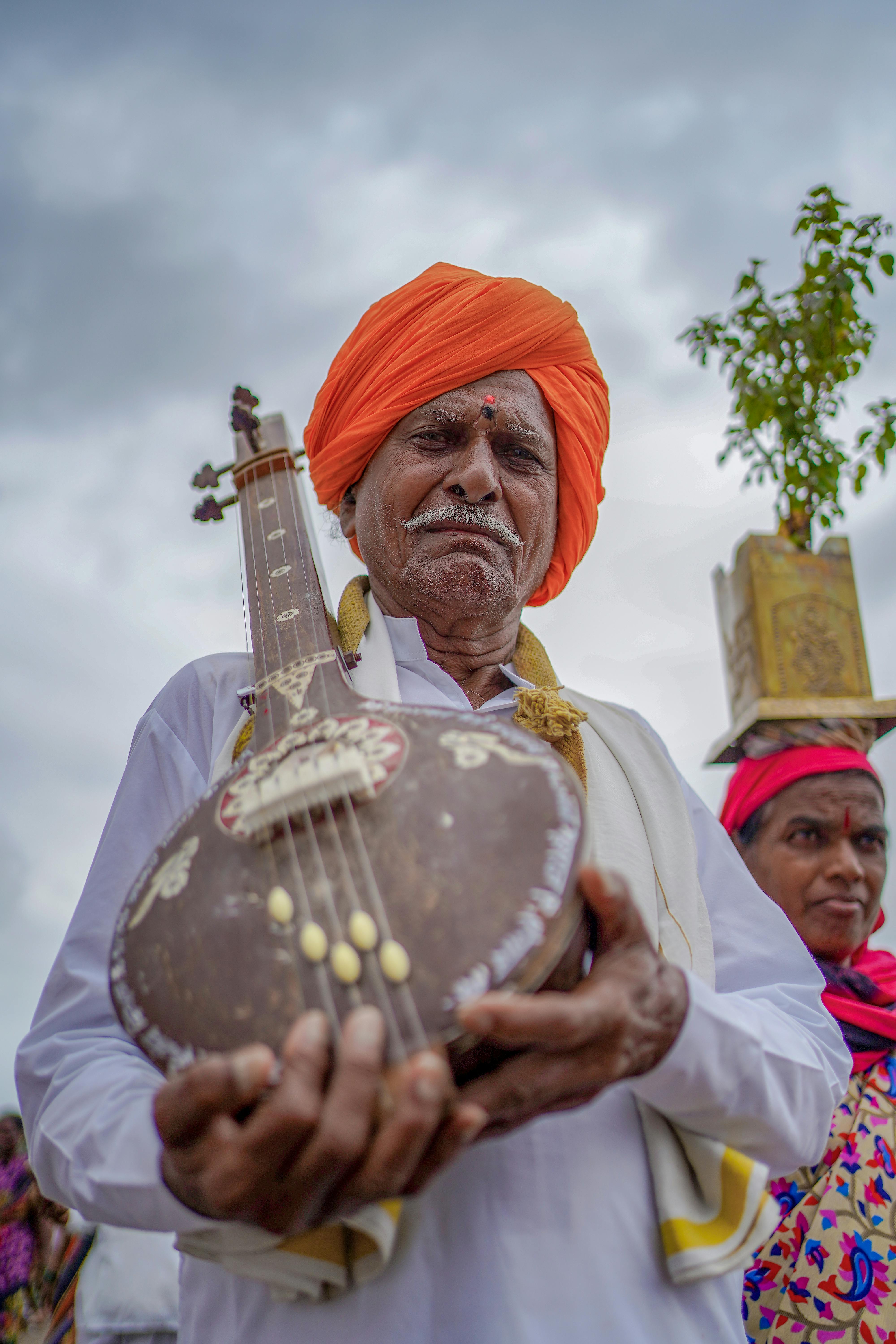 Men in Traditional Clothing Playing String Instruments at Sunset · Free ...