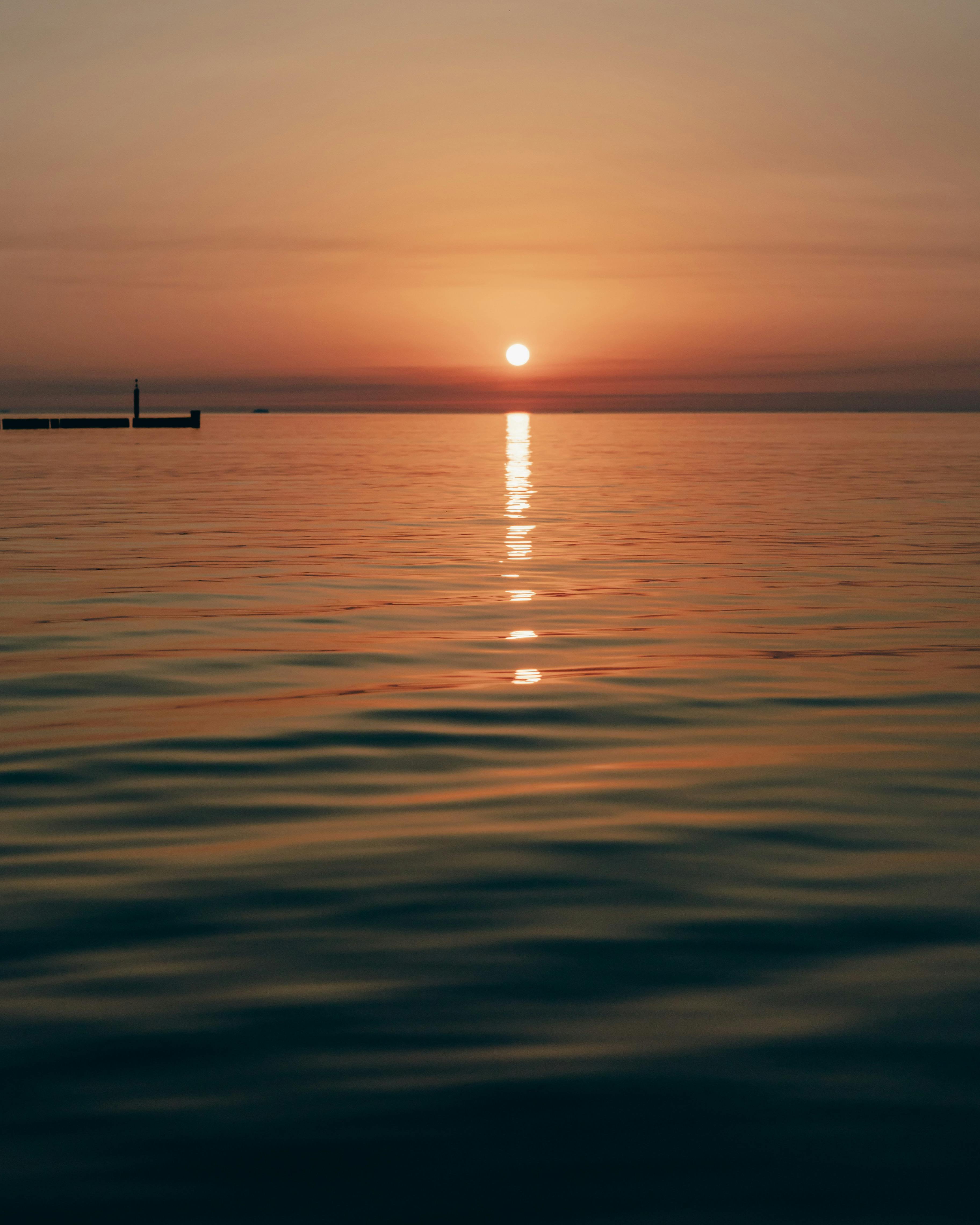 Photo of a Calm Sea during Sunset · Free Stock Photo