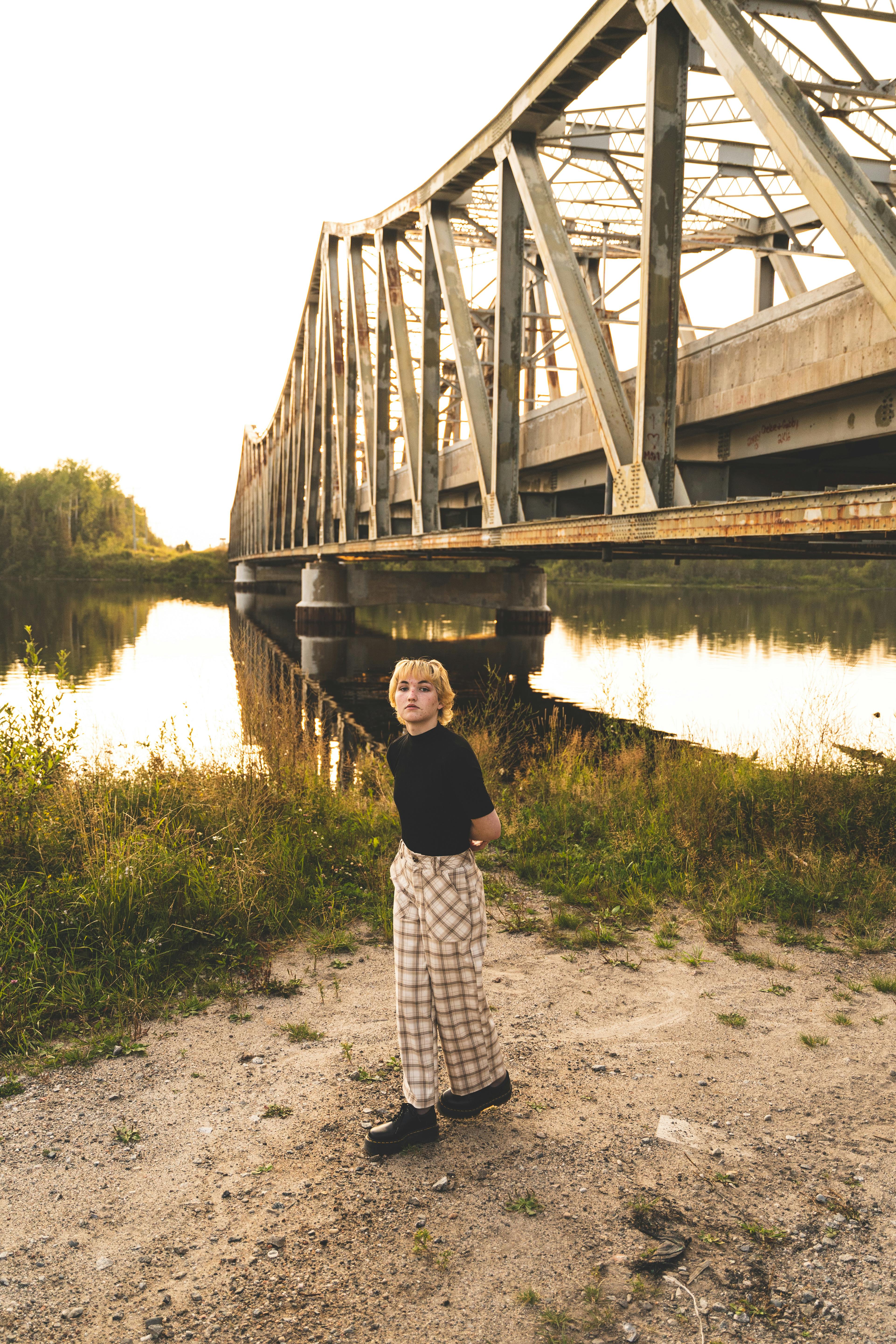Photo of a Girl Posing Near a Bridge · Free Stock Photo