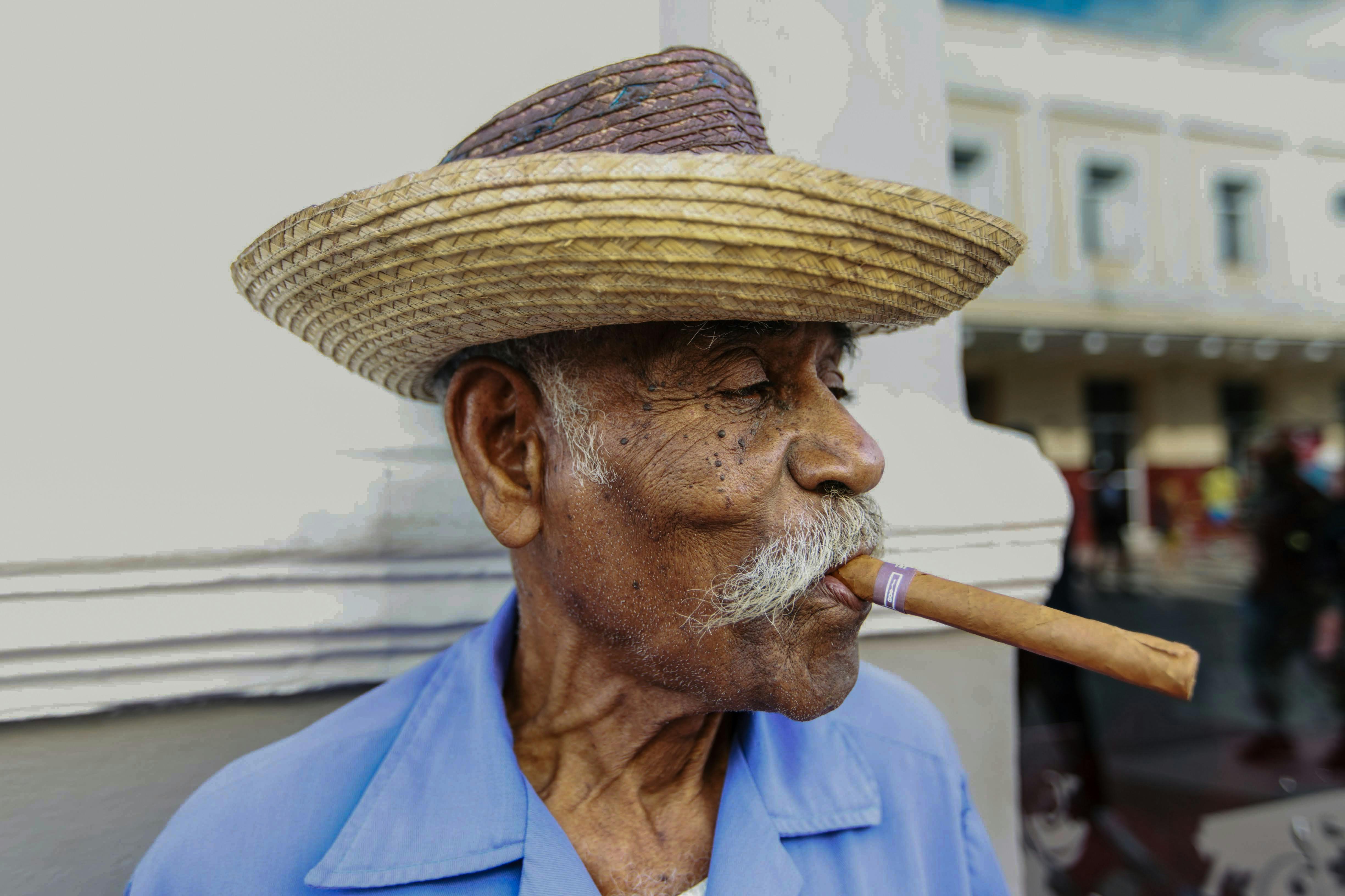 Close Up Photo of Elderly Man Wearing Straw Hat · Free Stock Photo