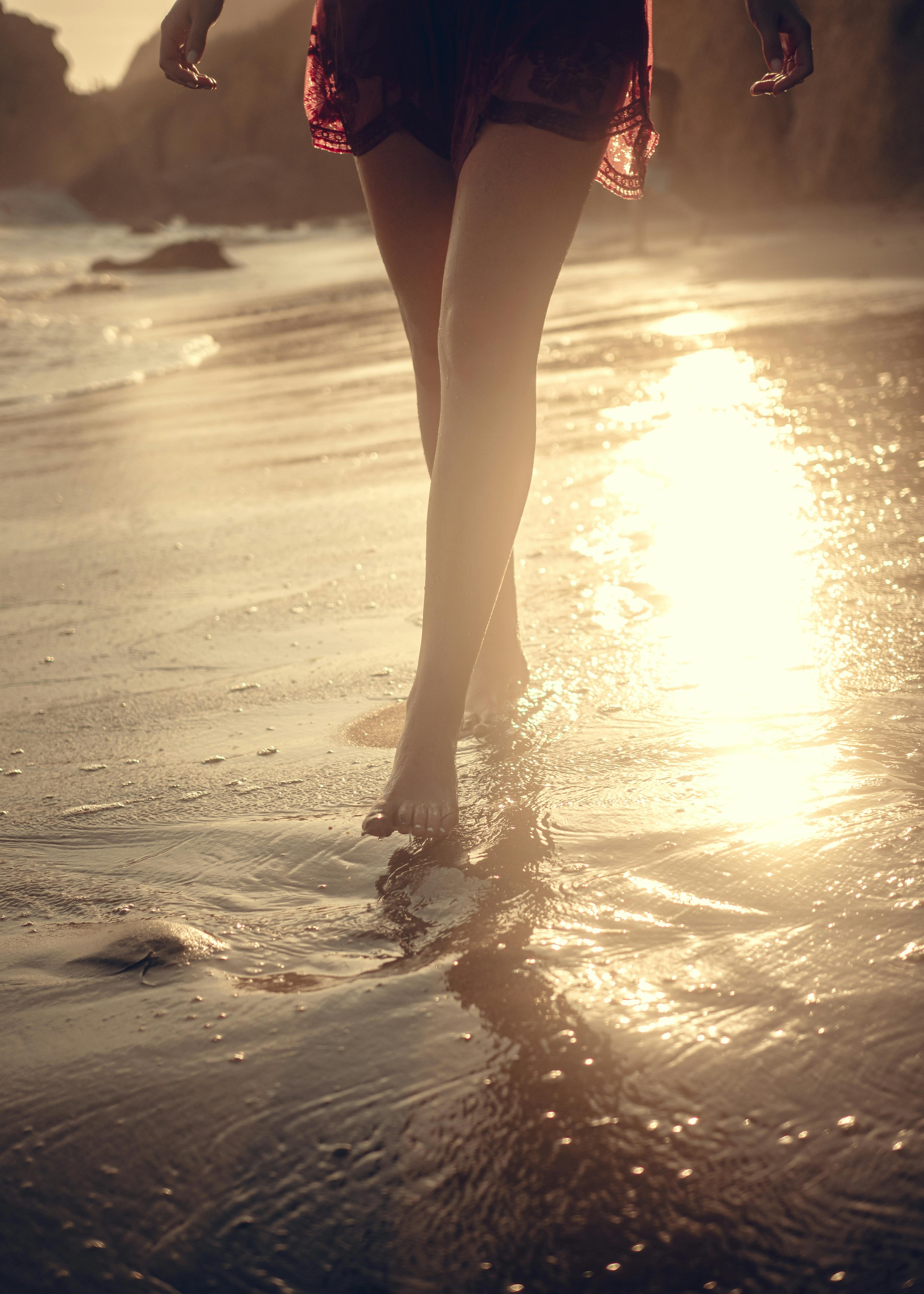 Person in White Robe Walking on Floor Tiles · Free Stock Photo