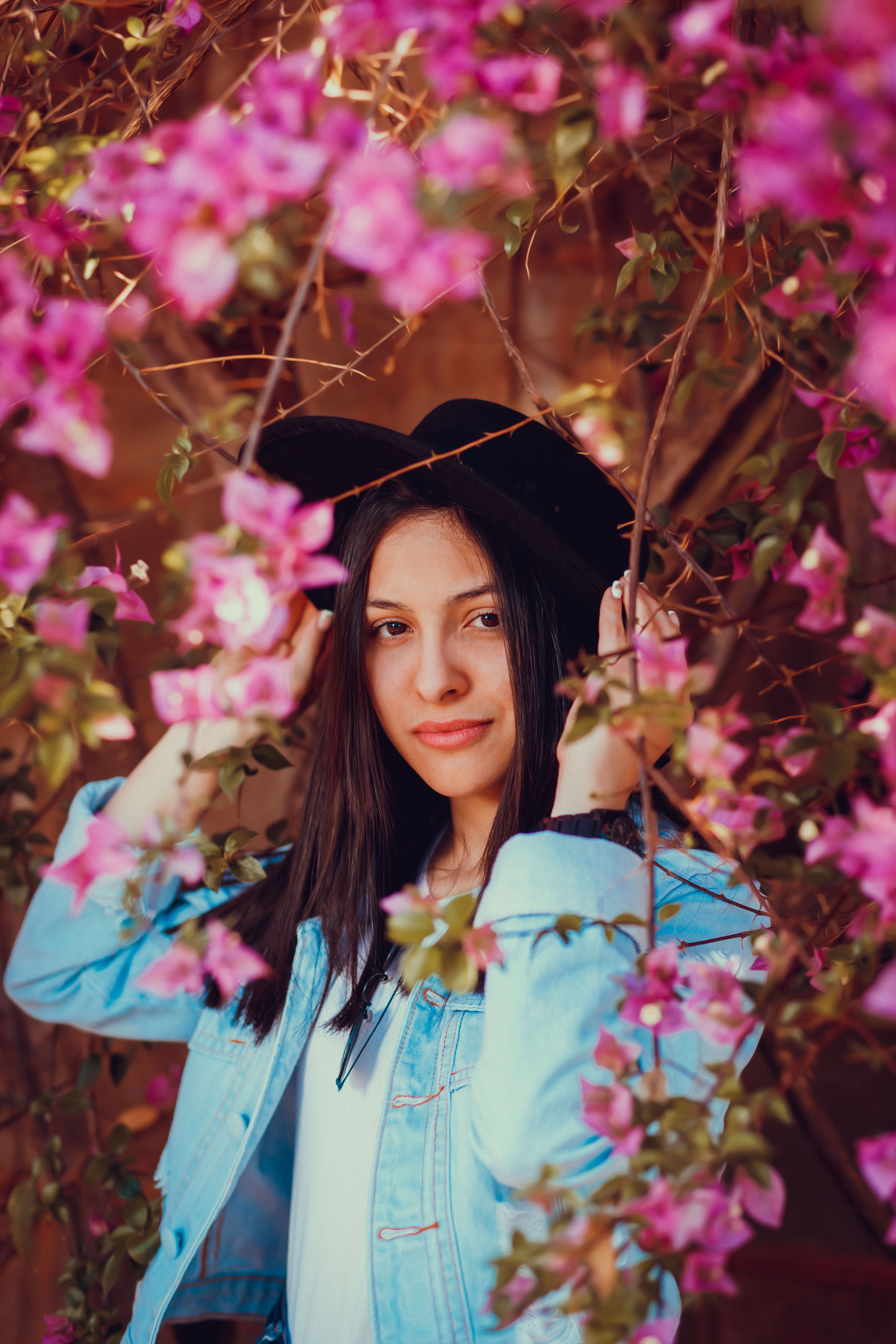 Pretty Woman Holding Black Beret Hat and a Denim Jacket · Free Stock Photo