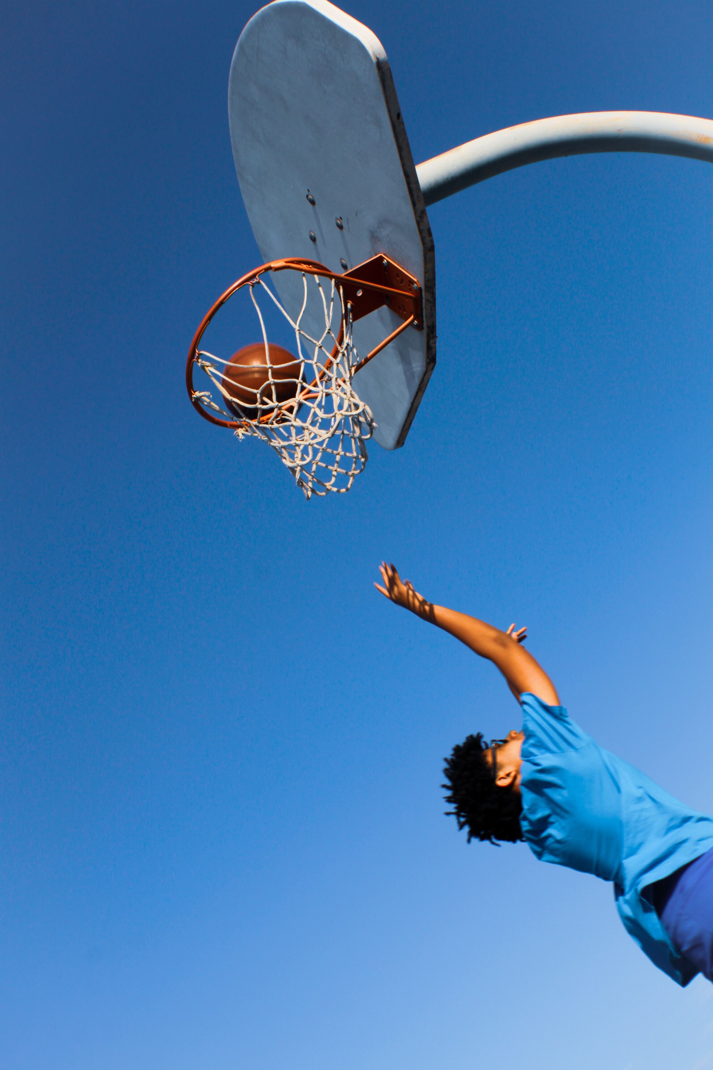 Man Dunking a Ball into the Basket on an Outdoor Basketball Court ...