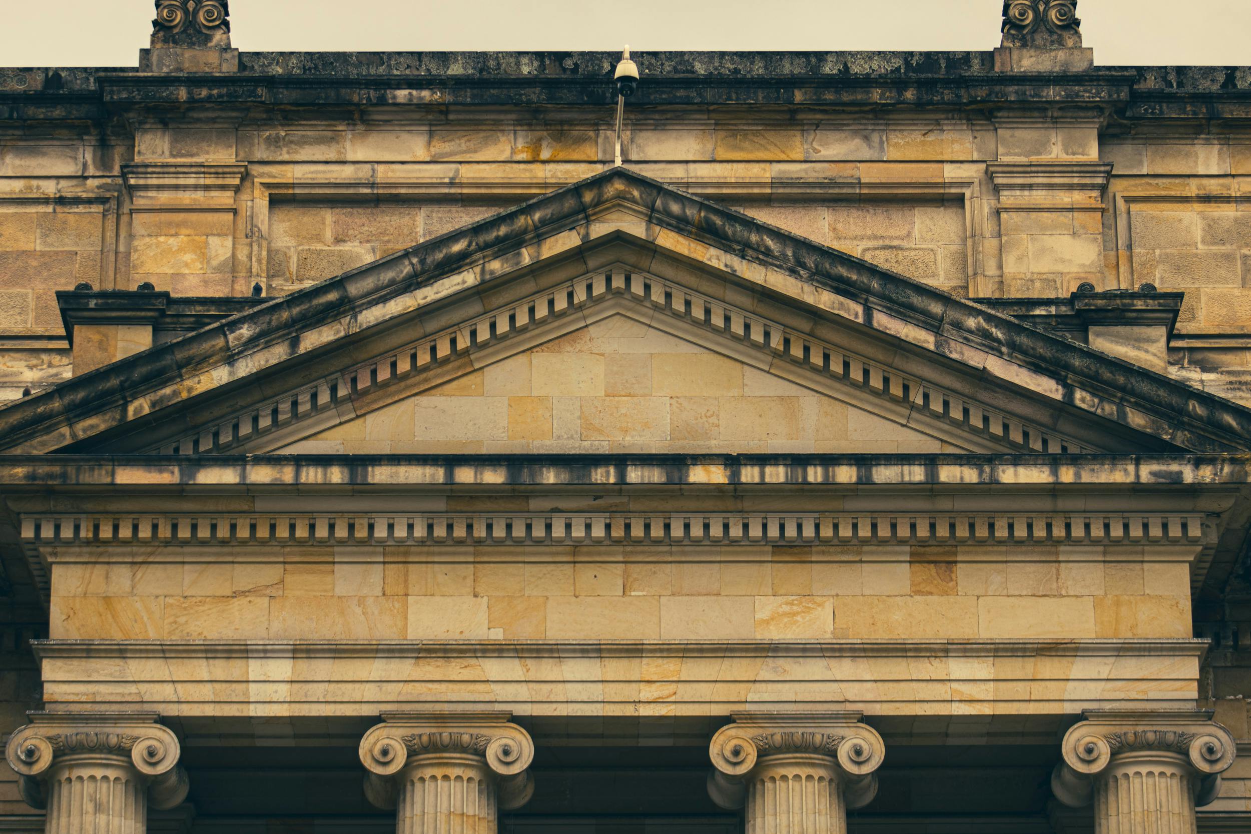 Roof Above the Columns of an Entrance of a Building · Free Stock Photo