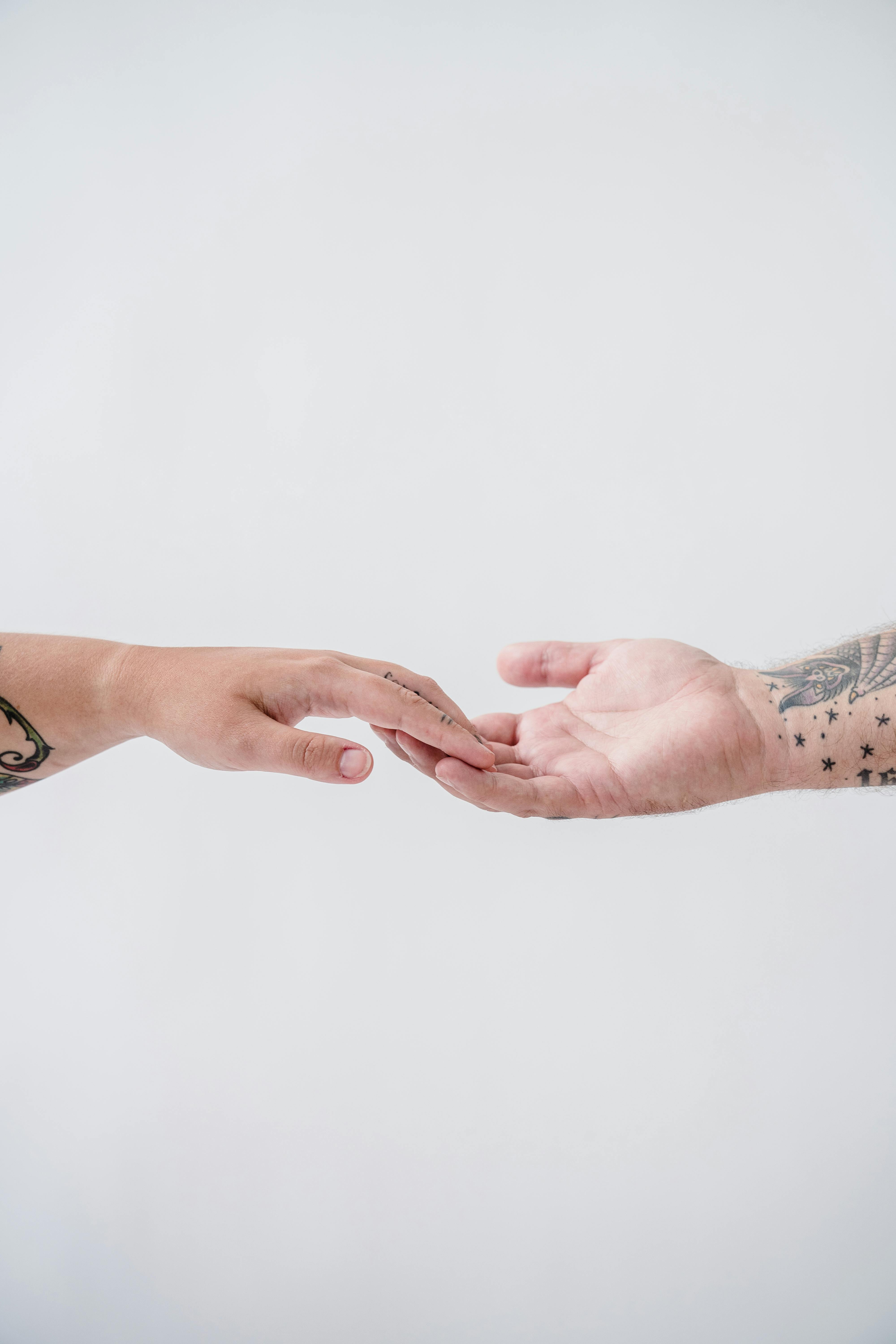 Close-up of Couple Hands Reaching for Touching · Free Stock Photo