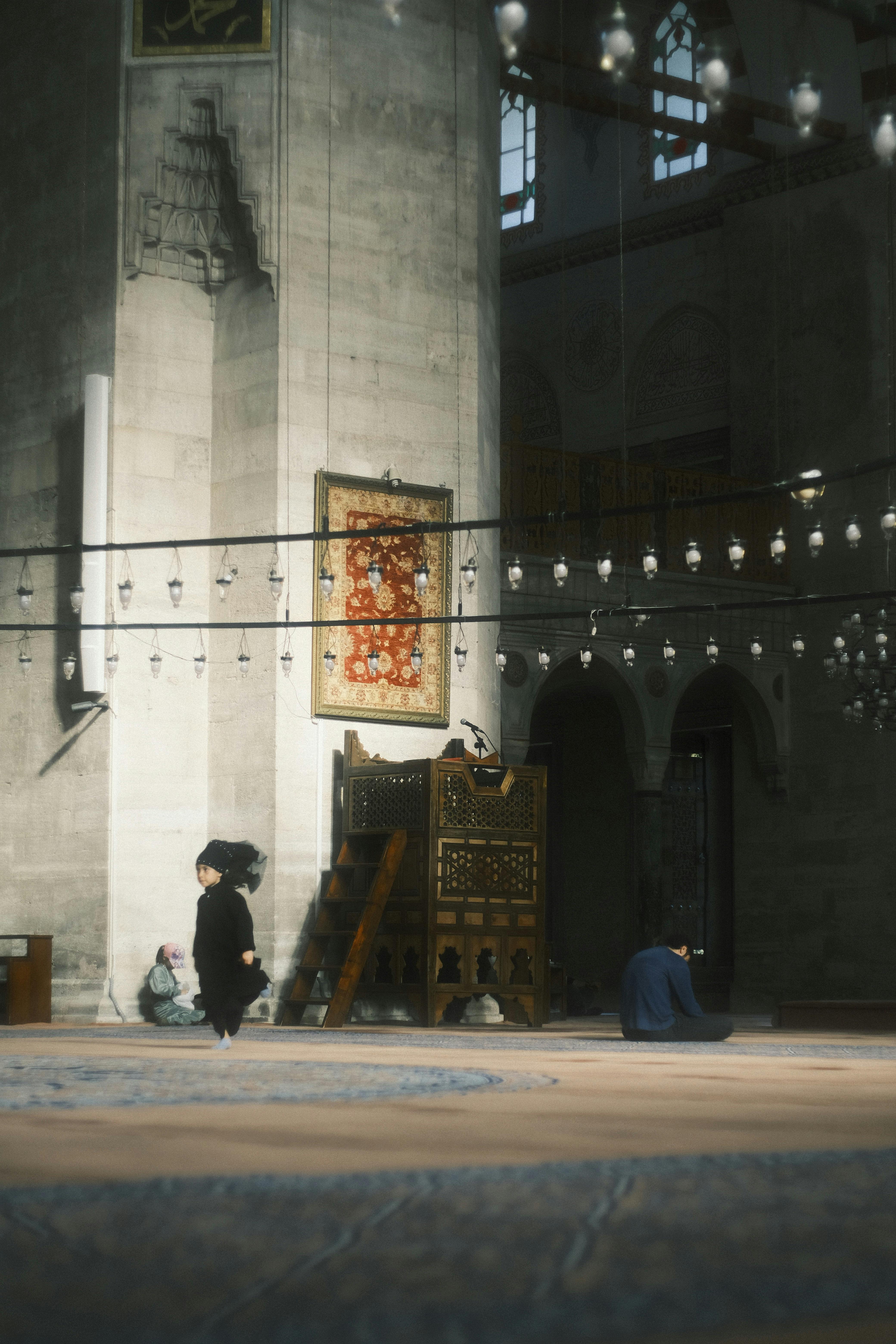 People Sitting and Praying in Mosque behind Peephole · Free Stock Photo