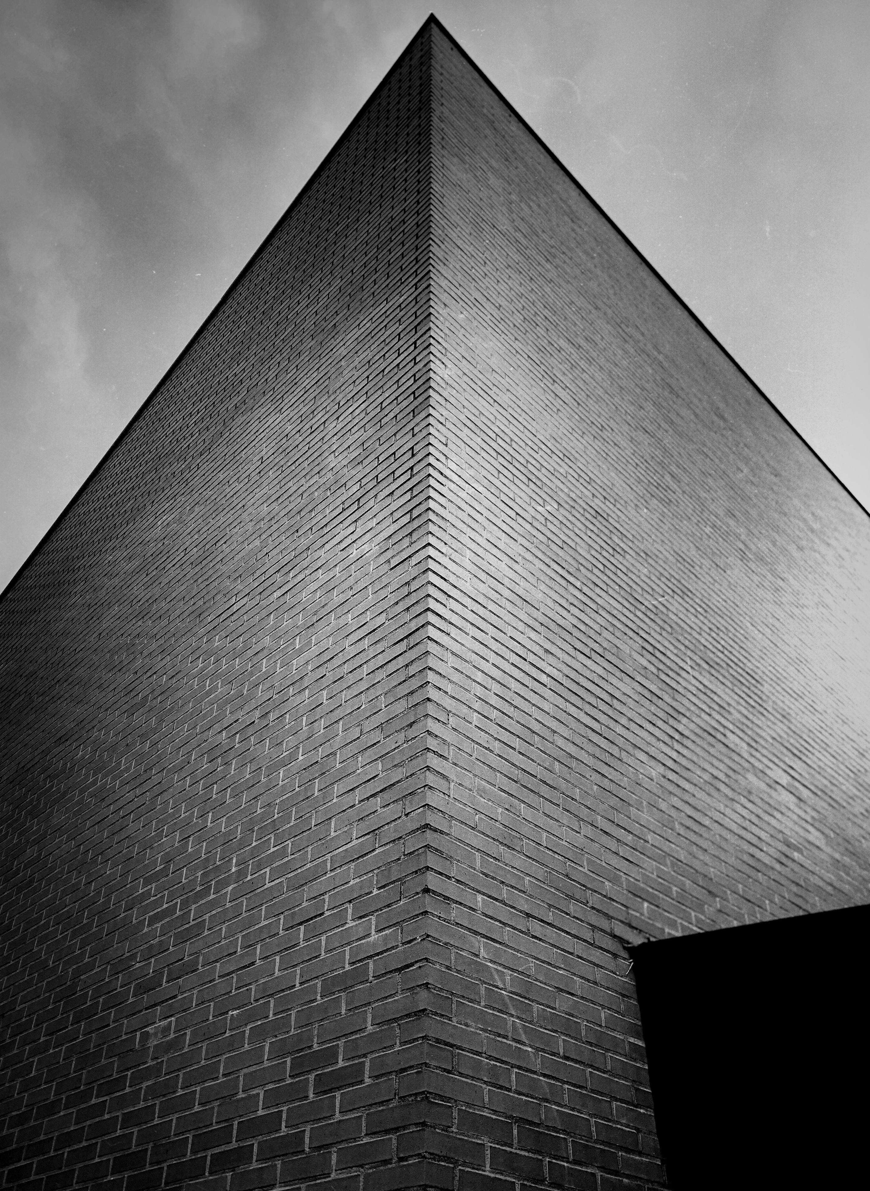 Grayscale Photo of a Brick Building · Free Stock Photo